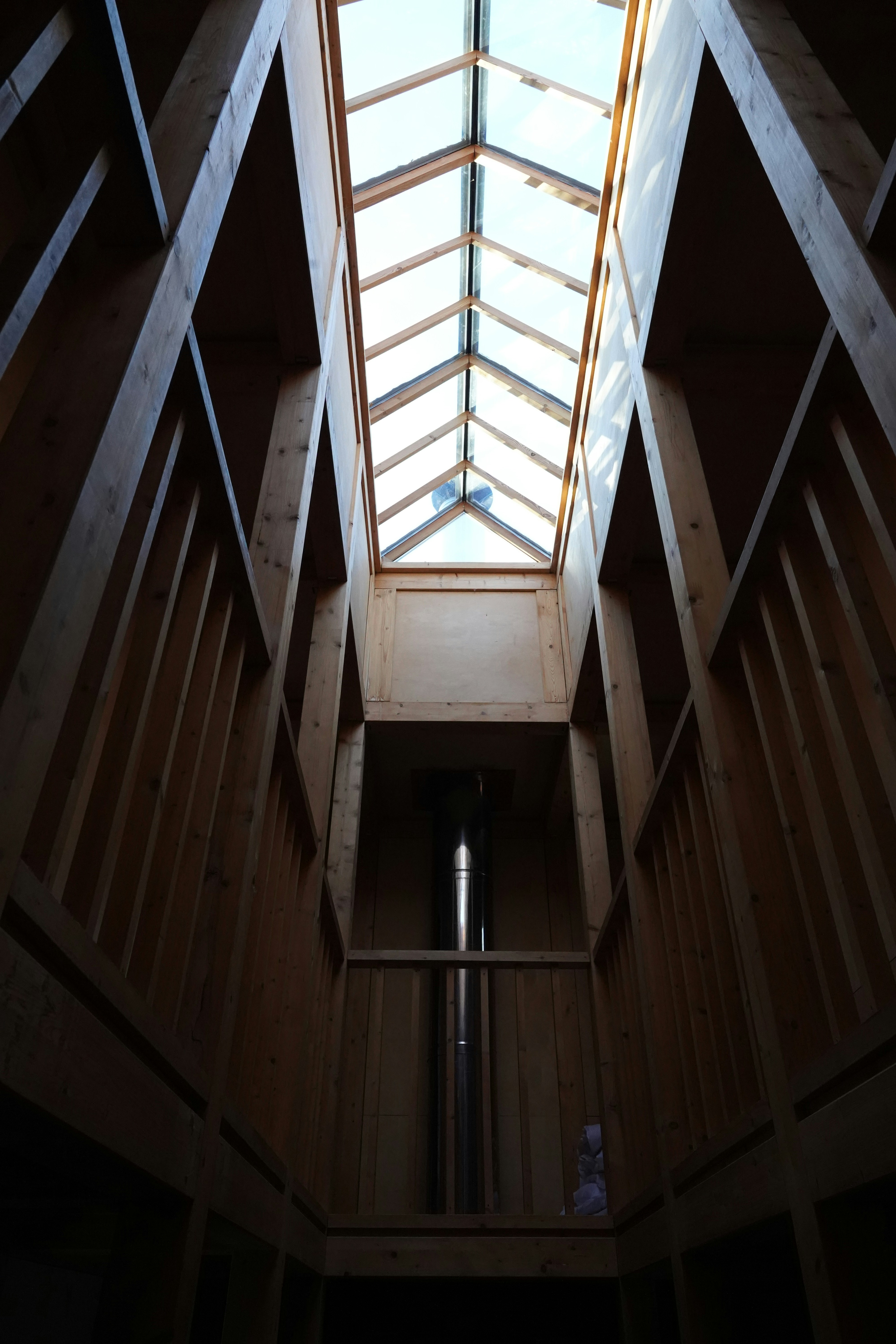A room with a skylight and wooden walls photo – Free Building Image on ...