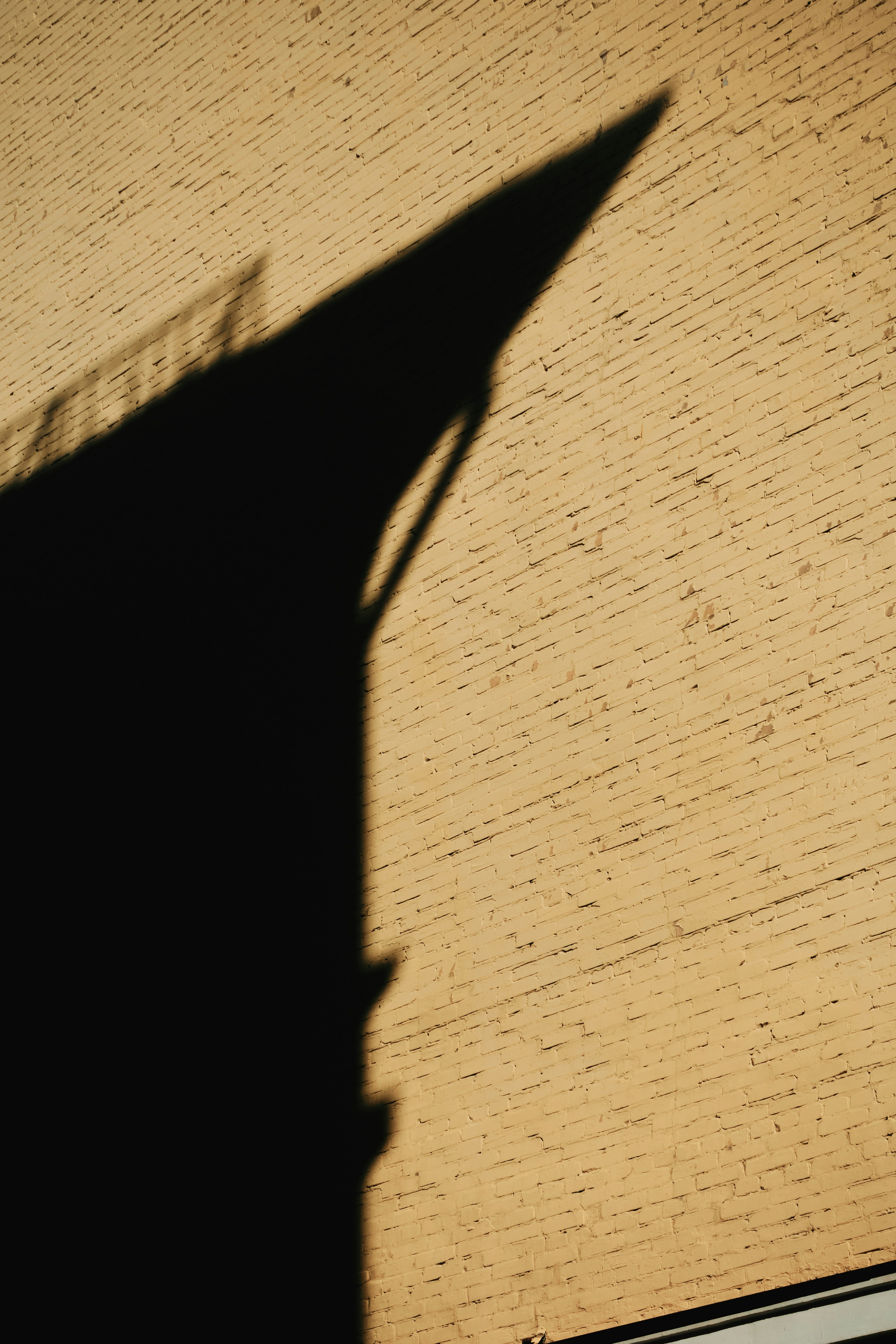 Shadow Spire on a Warm Facade