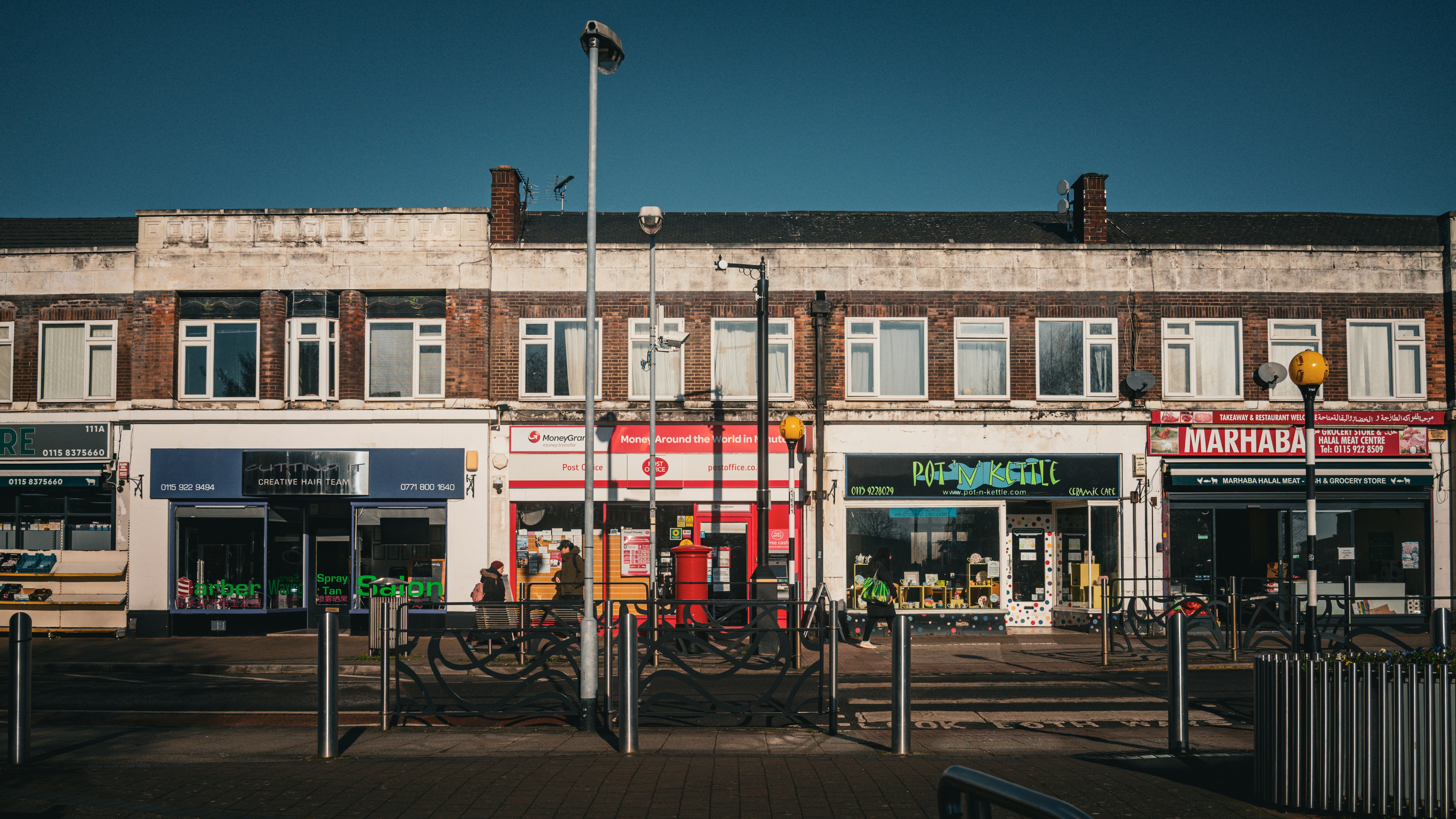 A row of stores sitting next to each other on a street photo – Free ...