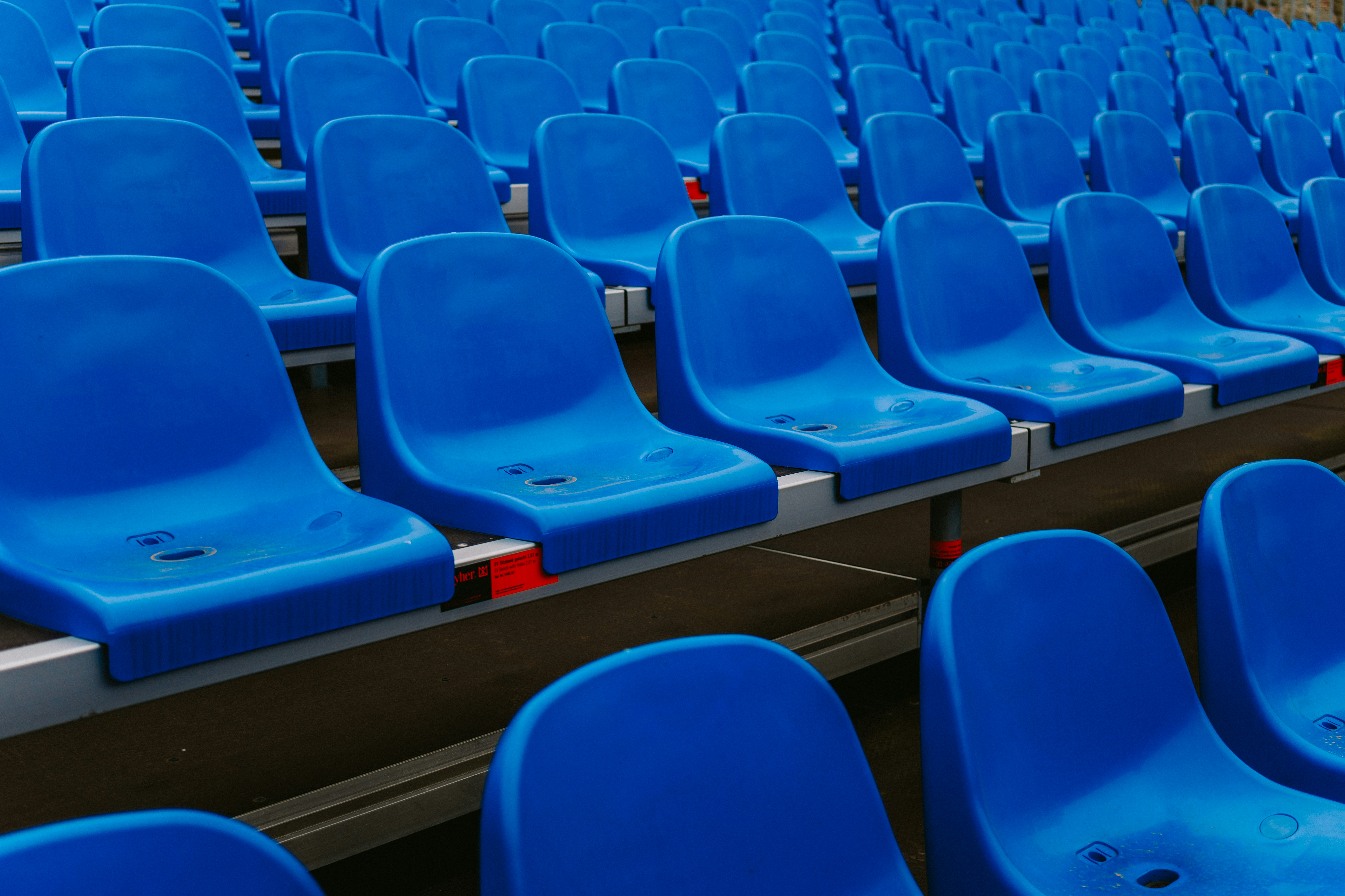 A row of blue chairs sitting next to each other photo – Free Blue Image ...