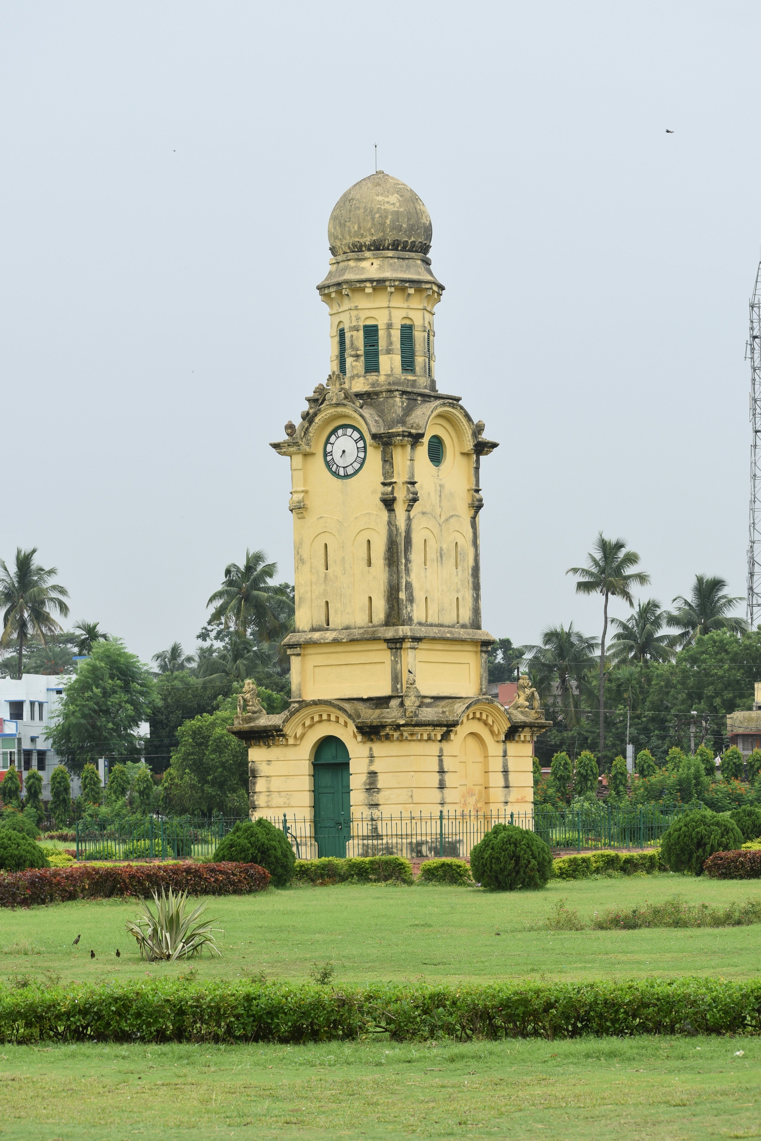Clocktower in a tropical garden: a weathered beacon