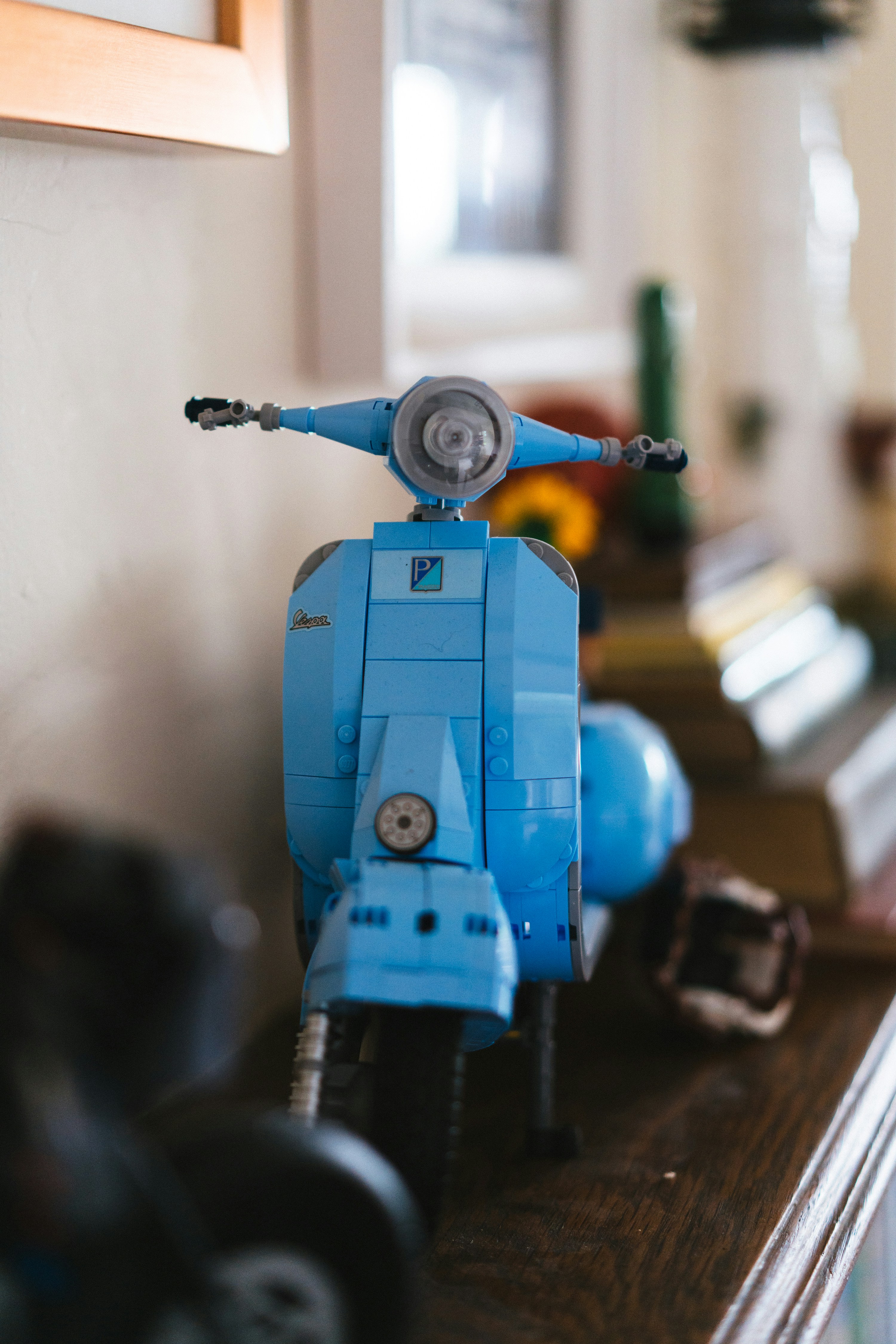 A blue toy motorcycle sitting on top of a wooden table photo – Free ...