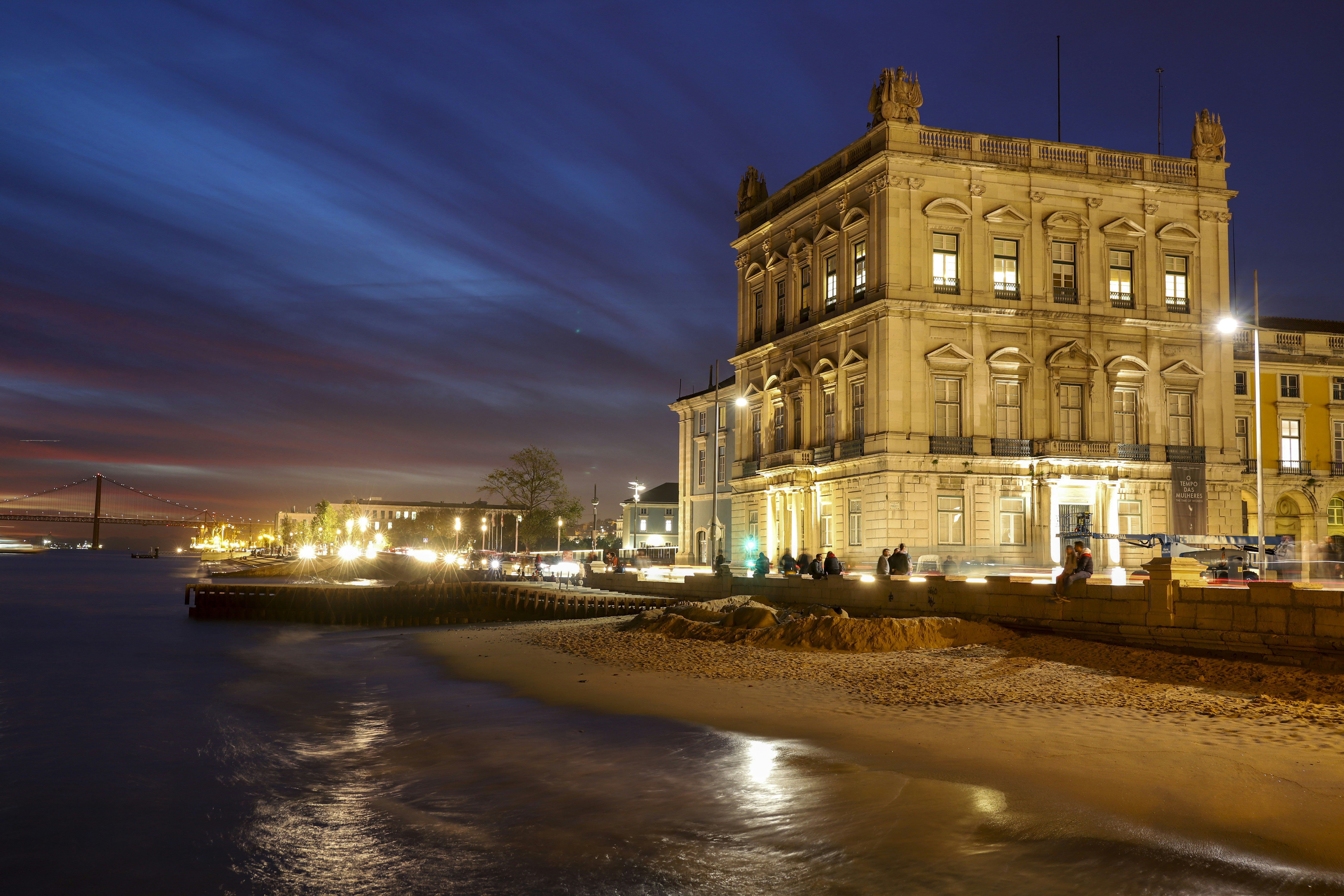Beaux-Arts Facade Bathes in Harbor Lights at Night