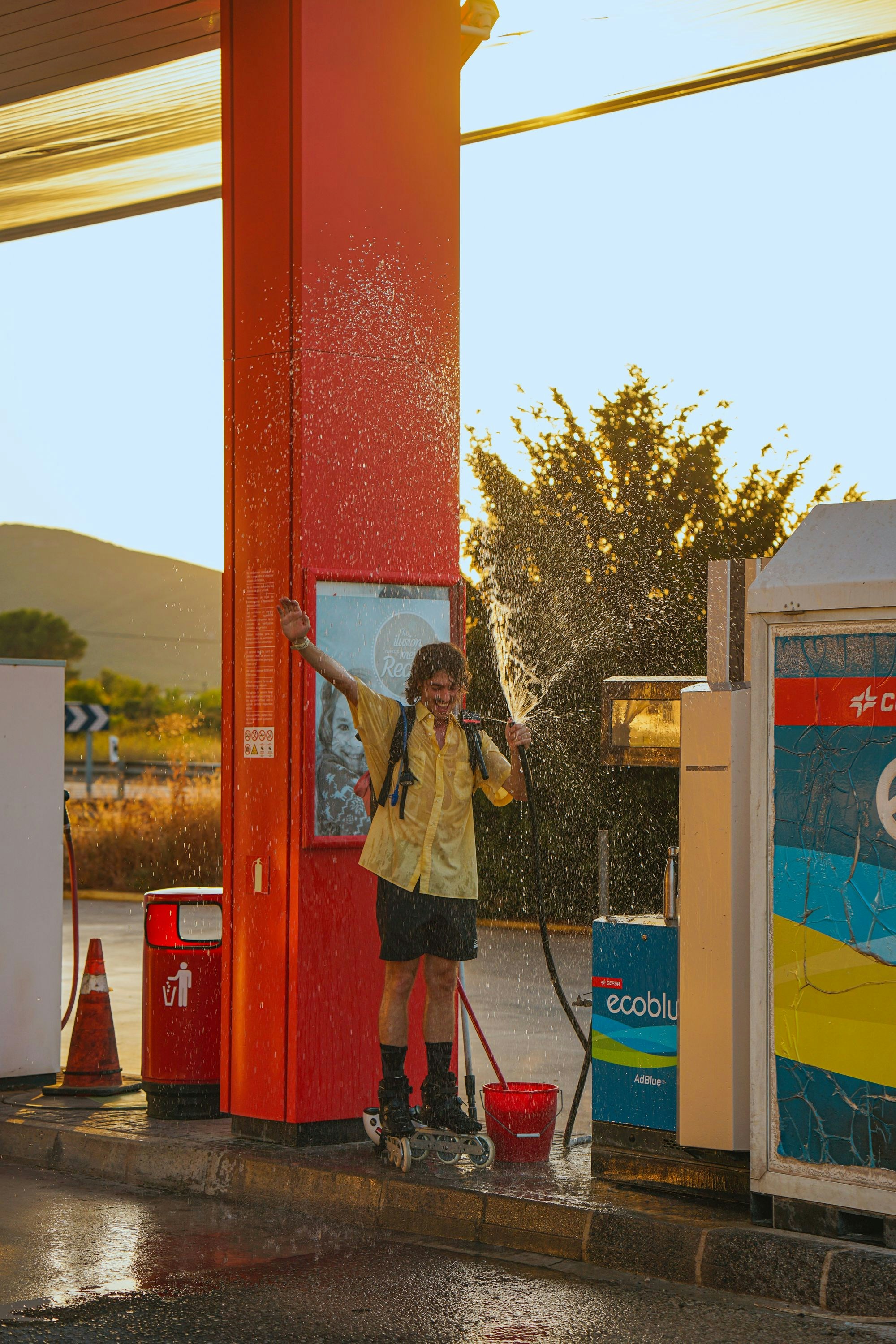 Sunset Spritz at the Pump: Rollerblader in a Gas-Station Shower