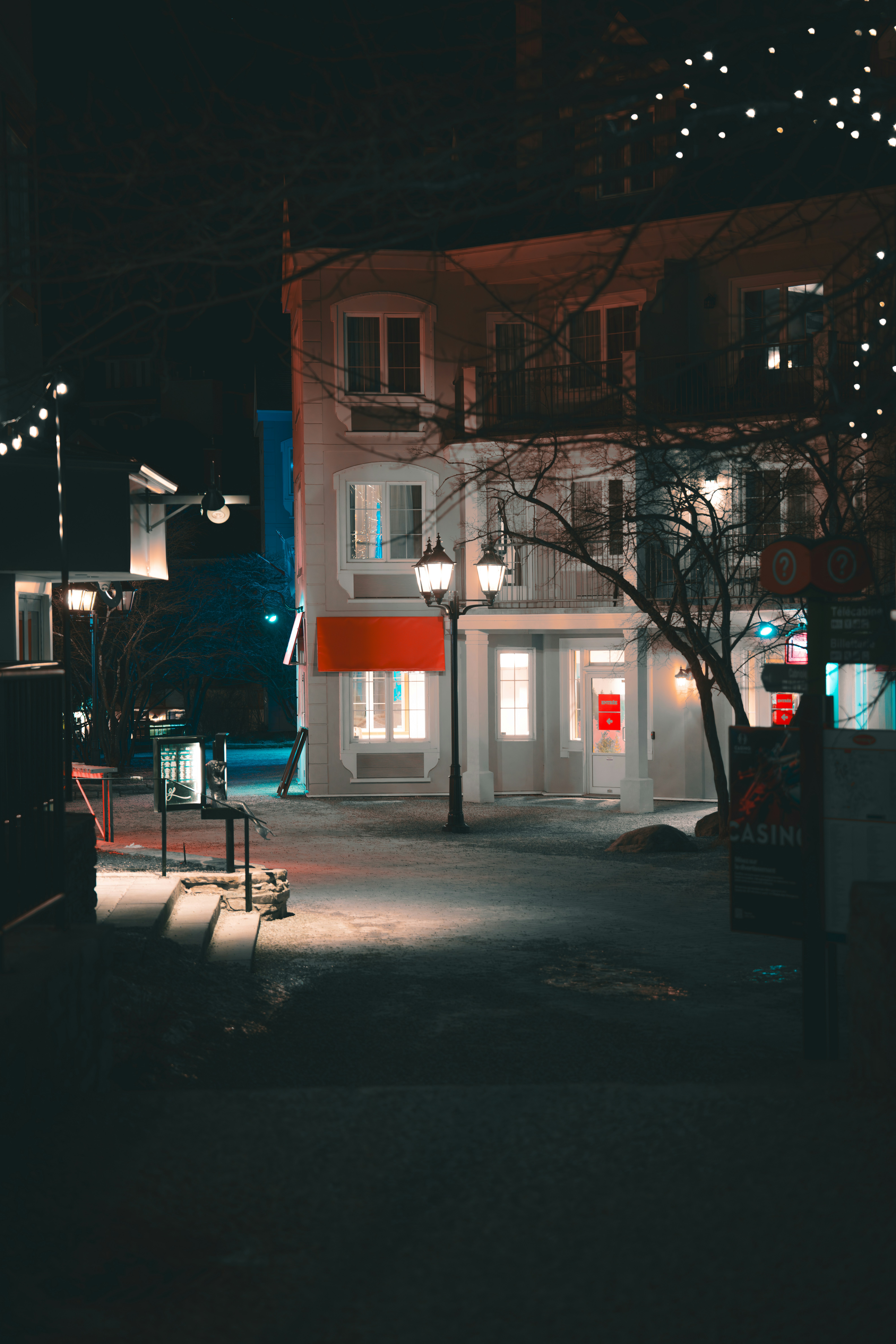 A building lit up at night with lights on photo – Free Building Image ...