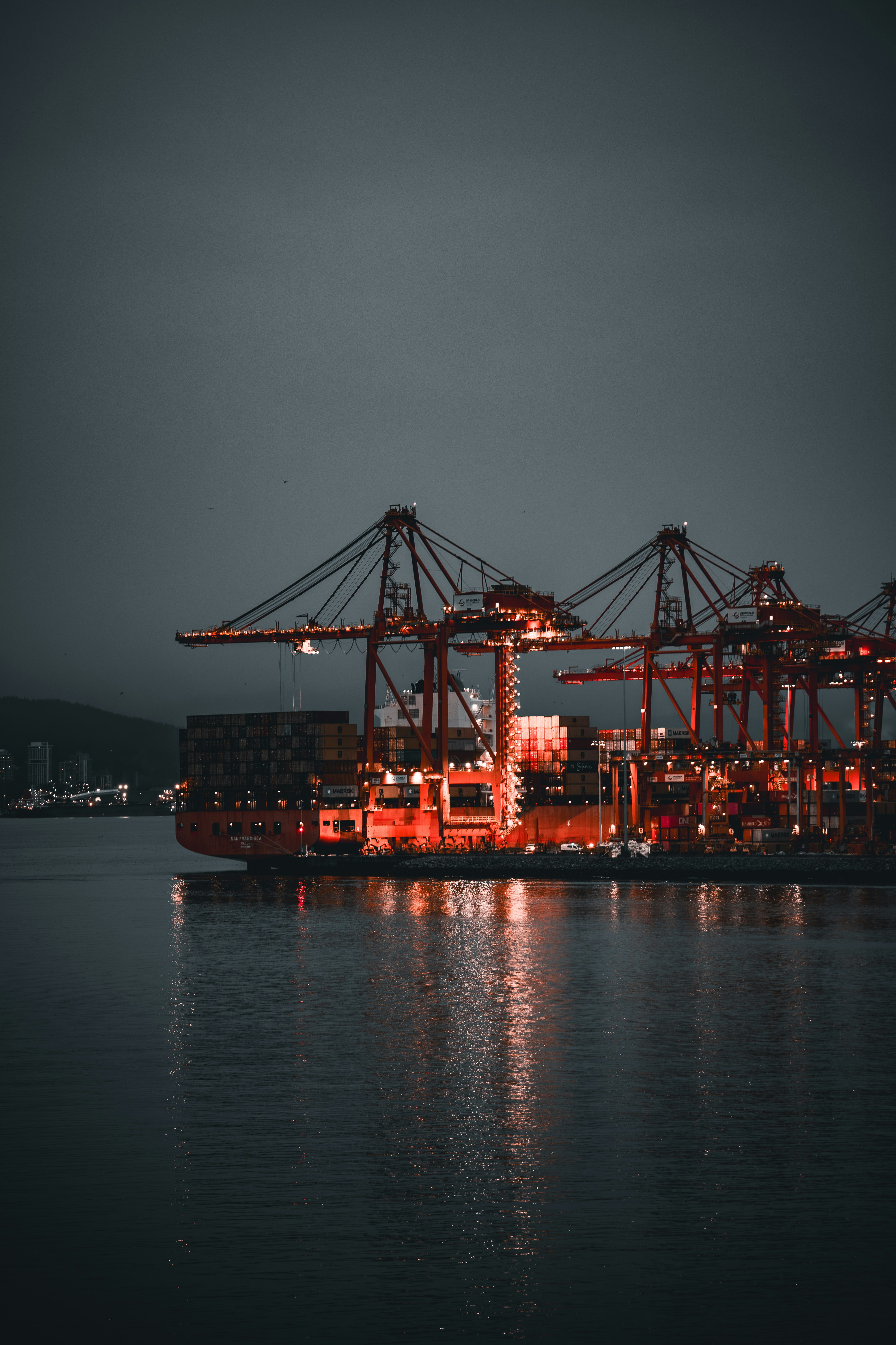 A large container ship in the water at night photo – Free Iphone ...