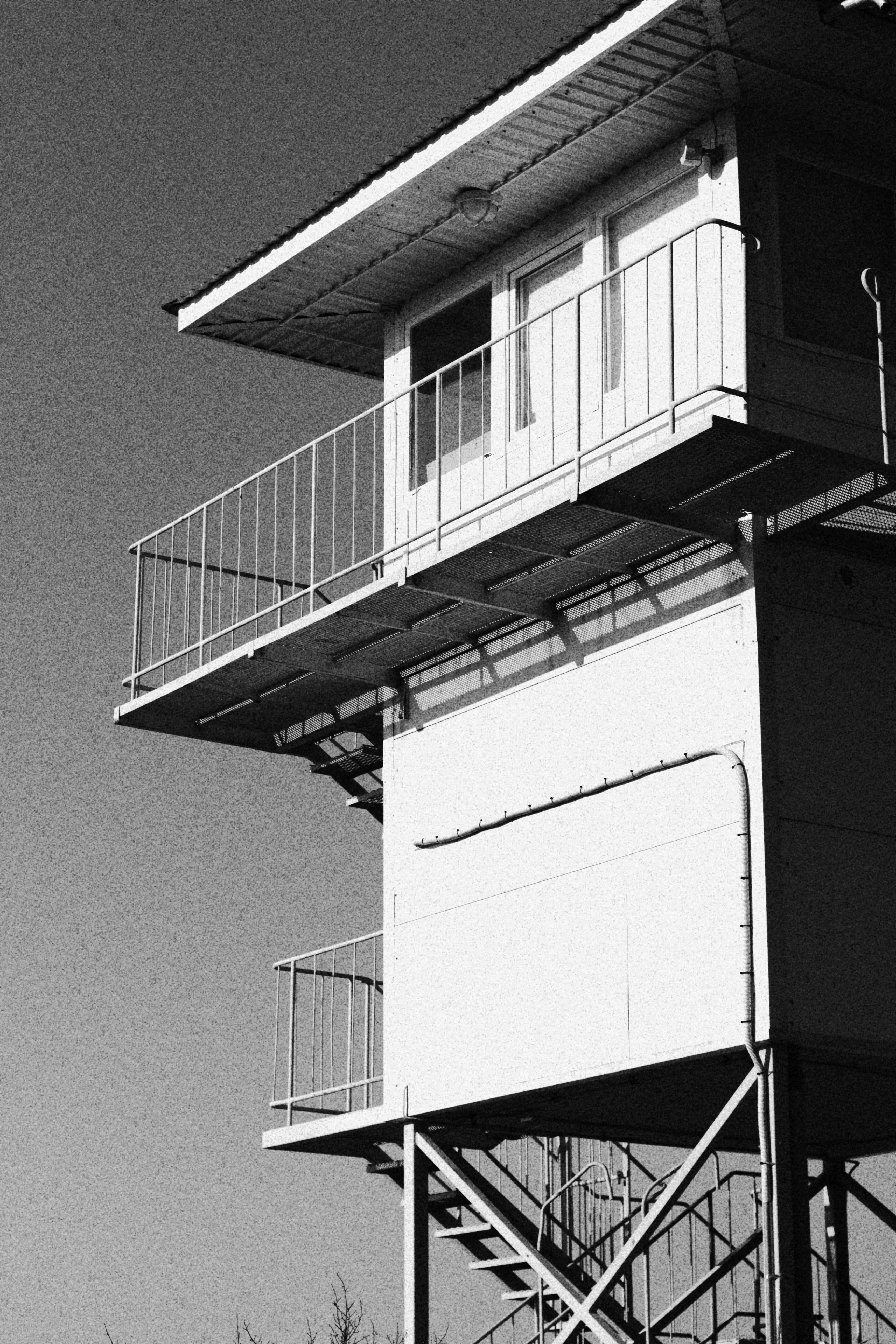 Elevated Watchtower: A stark black-and-white study of steel and shadow