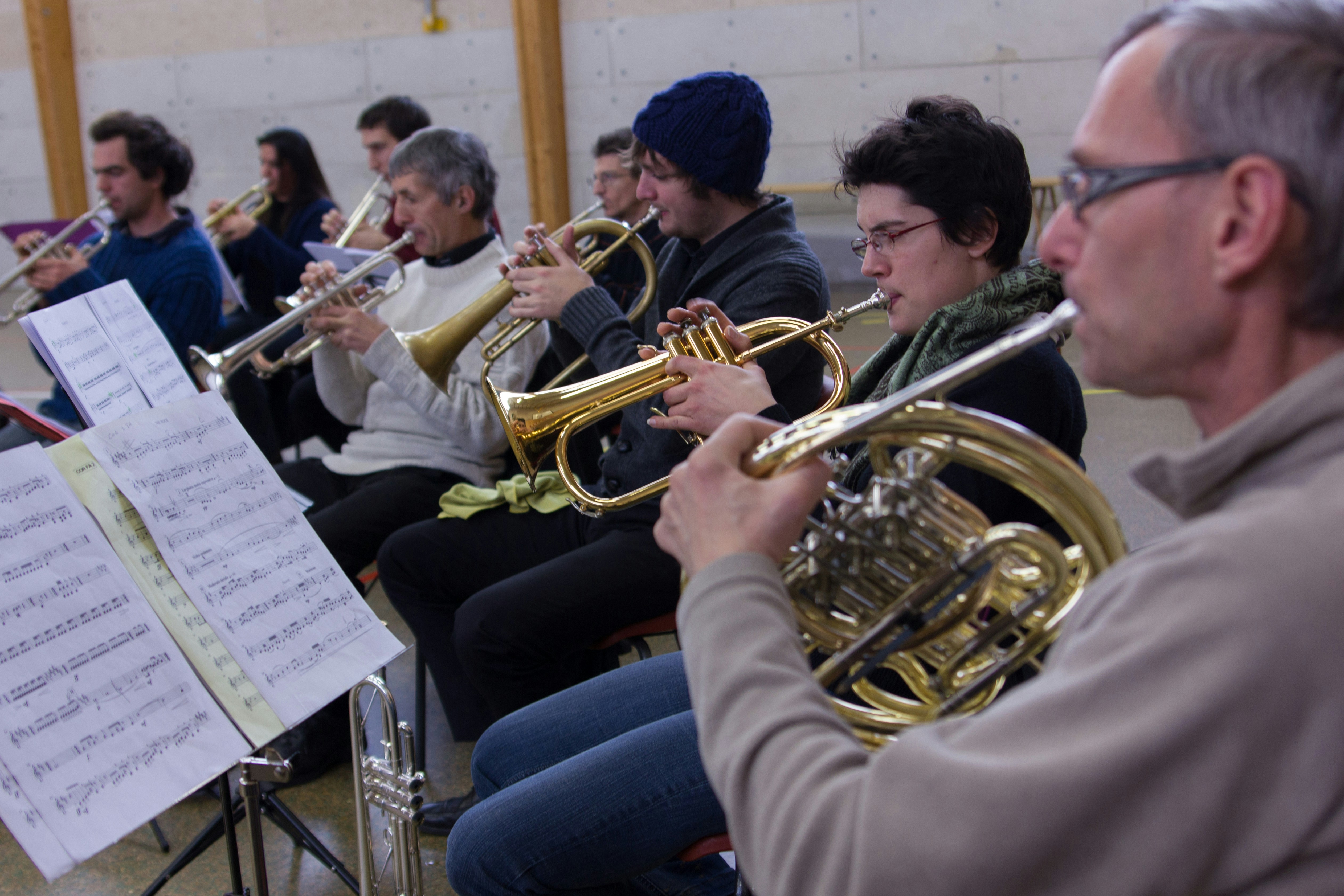 A group of people playing musical instruments in a room photo – Free ...