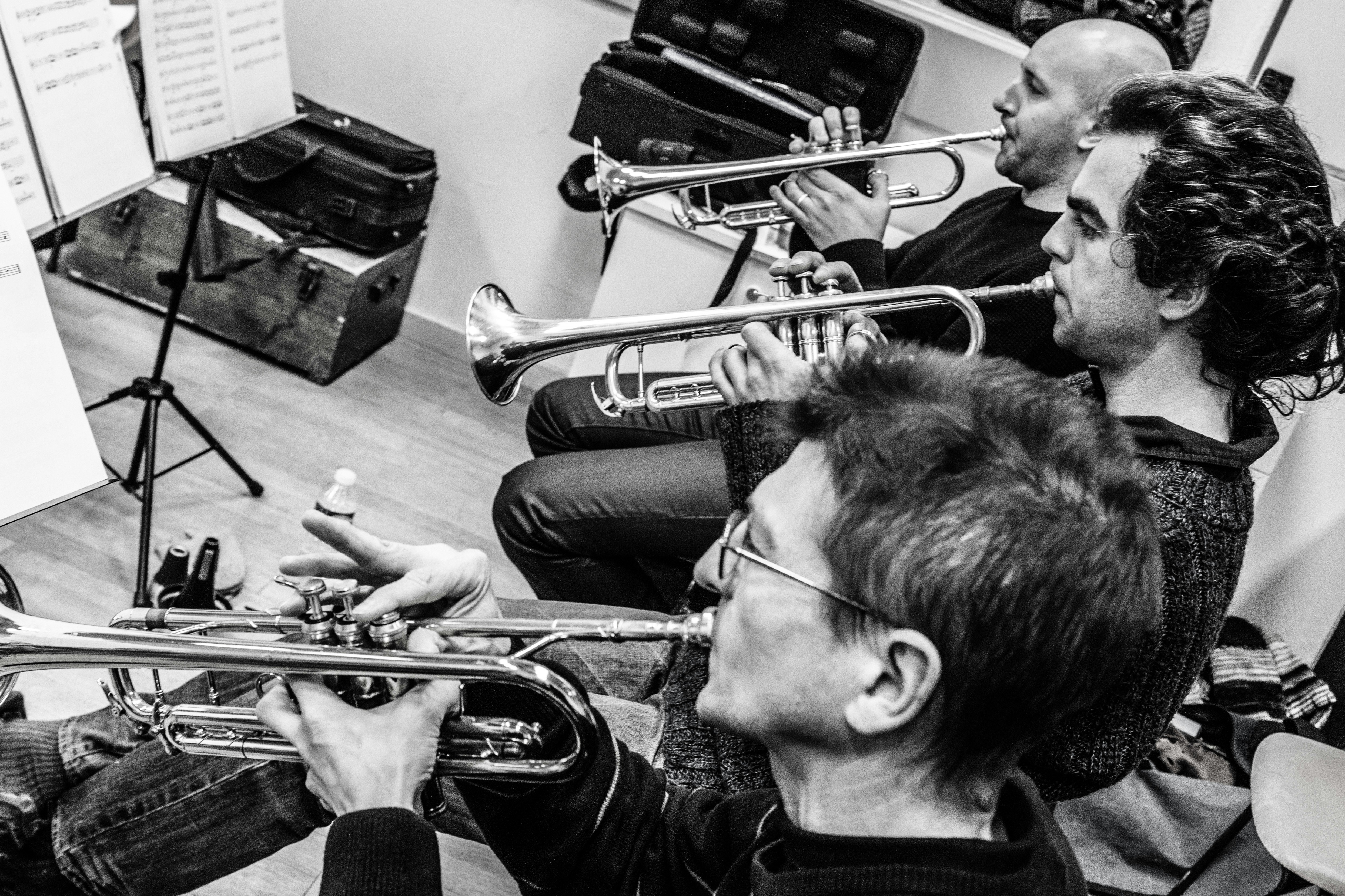 A group of men playing musical instruments in a room photo – Free Man ...