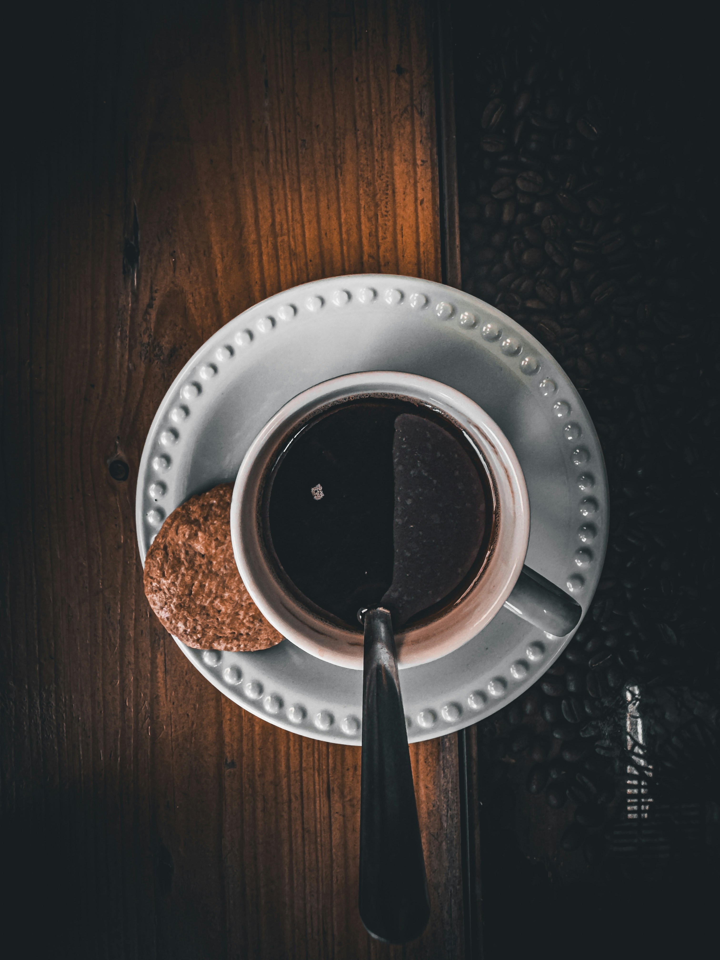 Top-Down Brew: Coffee Cup on a Beaded Saucer with a Cookie