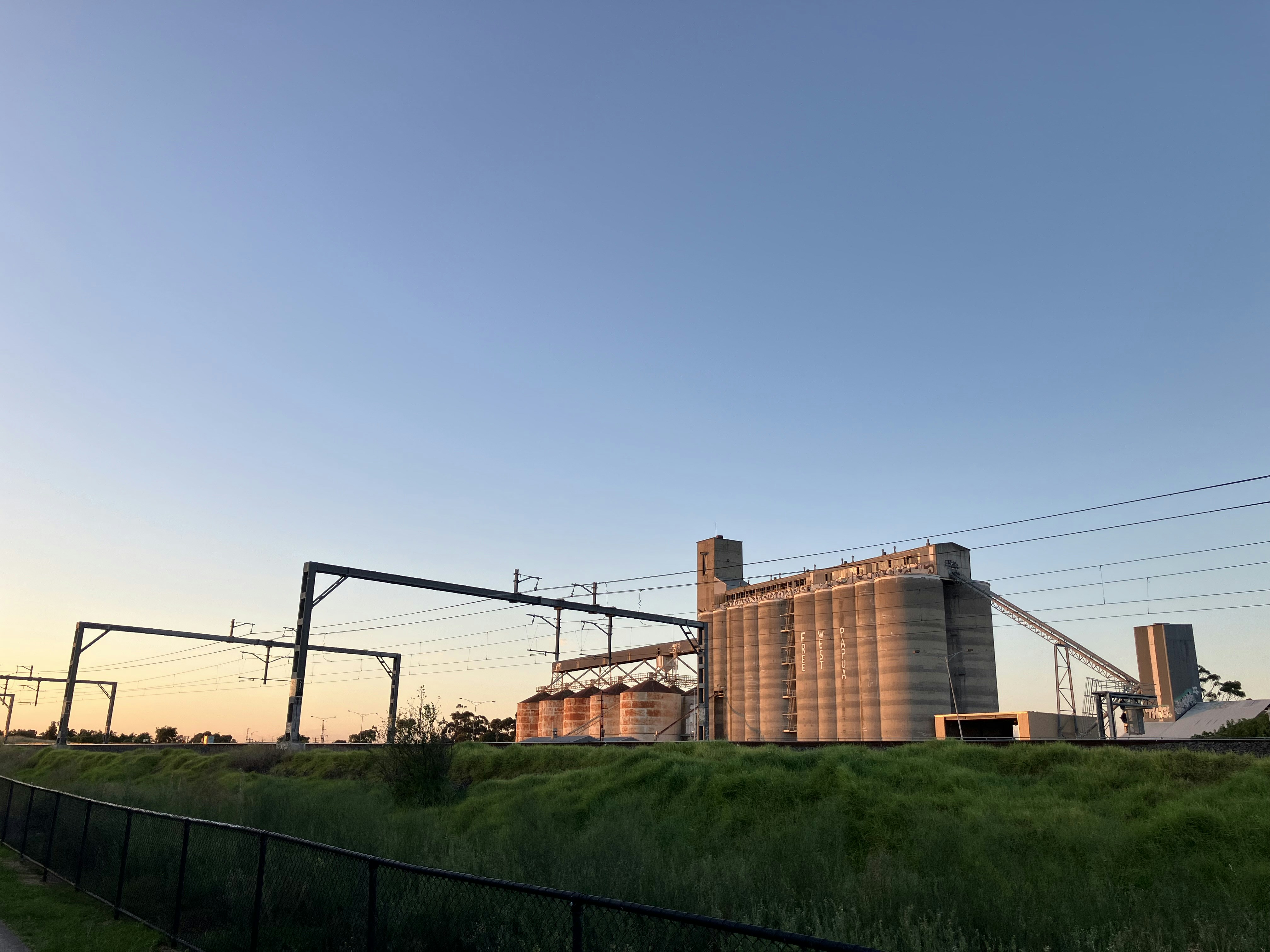 a large building sitting on top of a lush green field