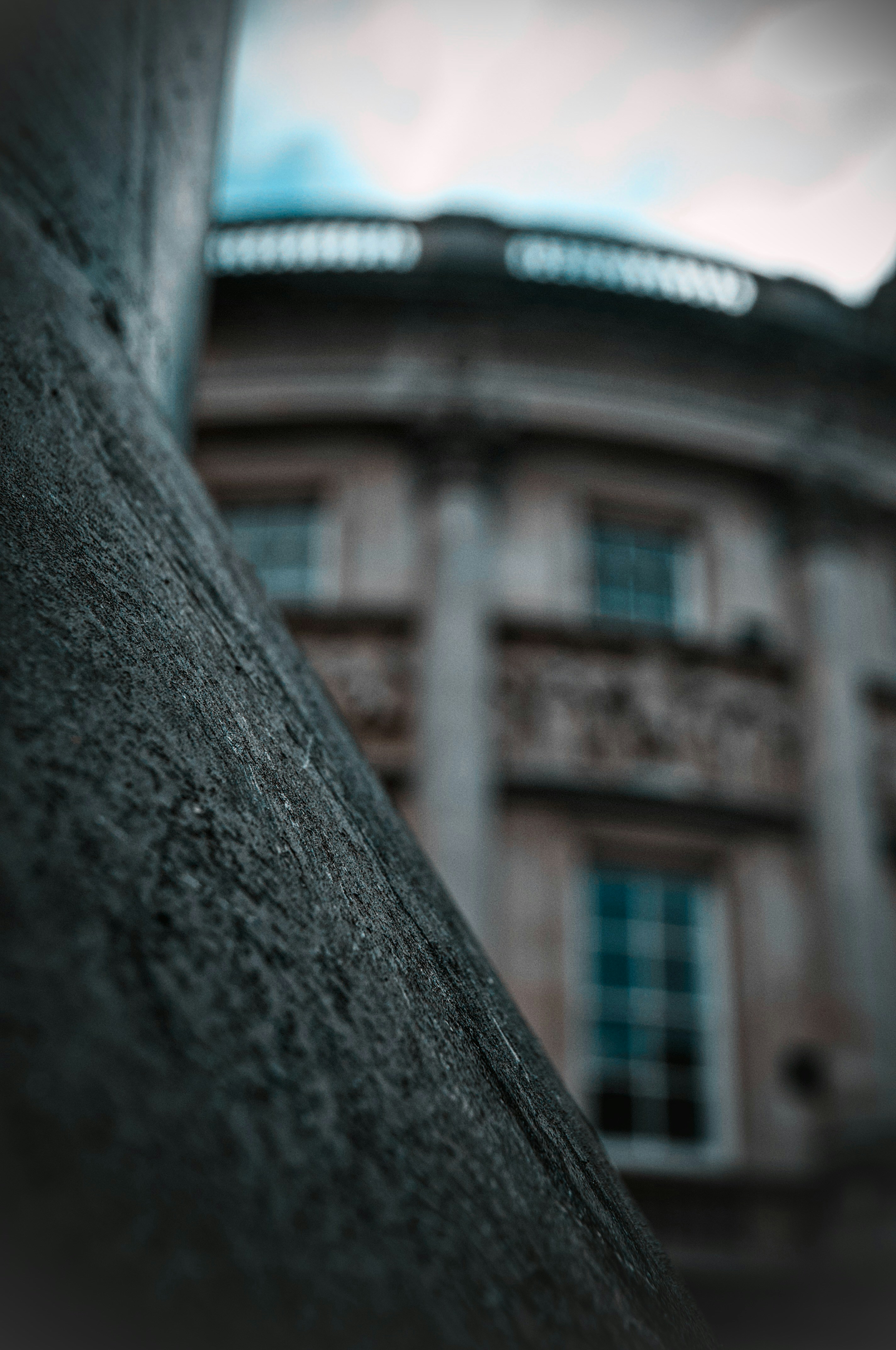 Edge of Time: Close-Up of Weathered Stone Beside a Faded Facade
