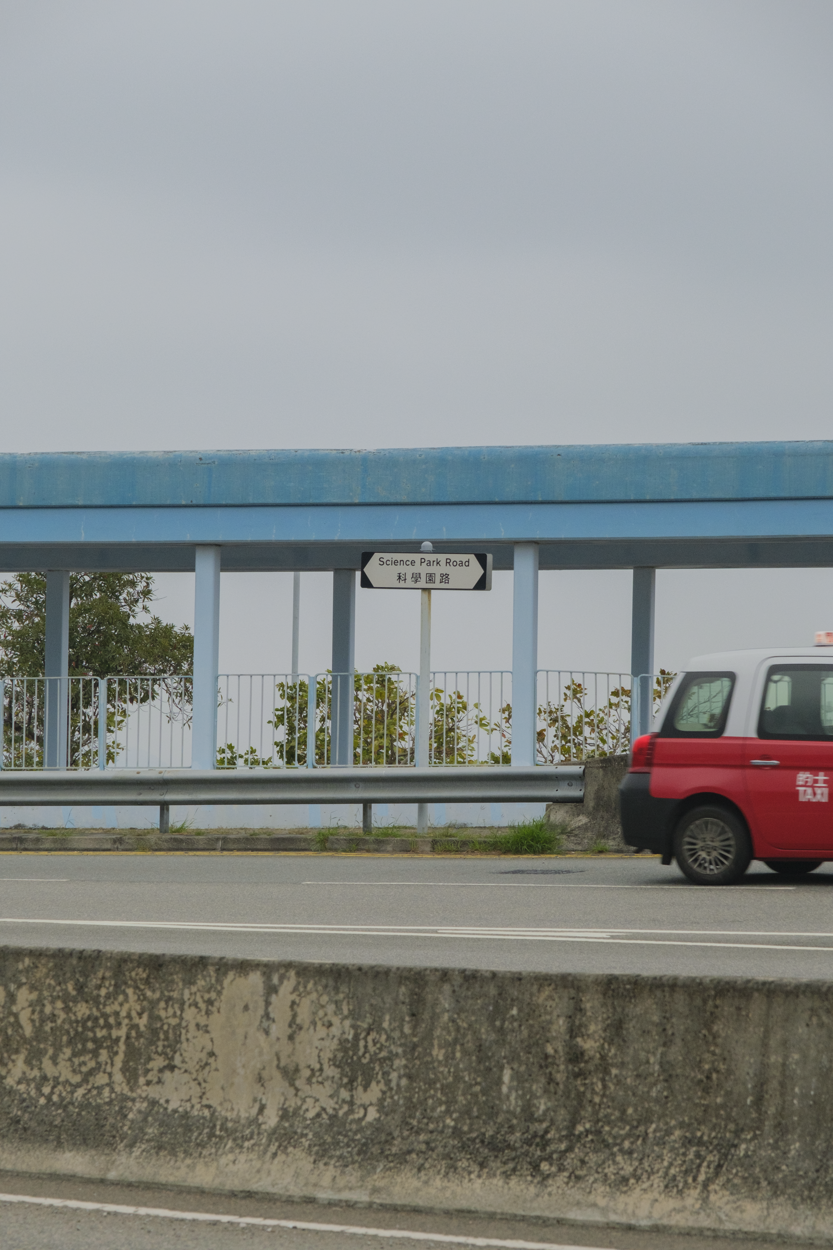Blue Span over a Quiet Highway: Red Van in Transit
