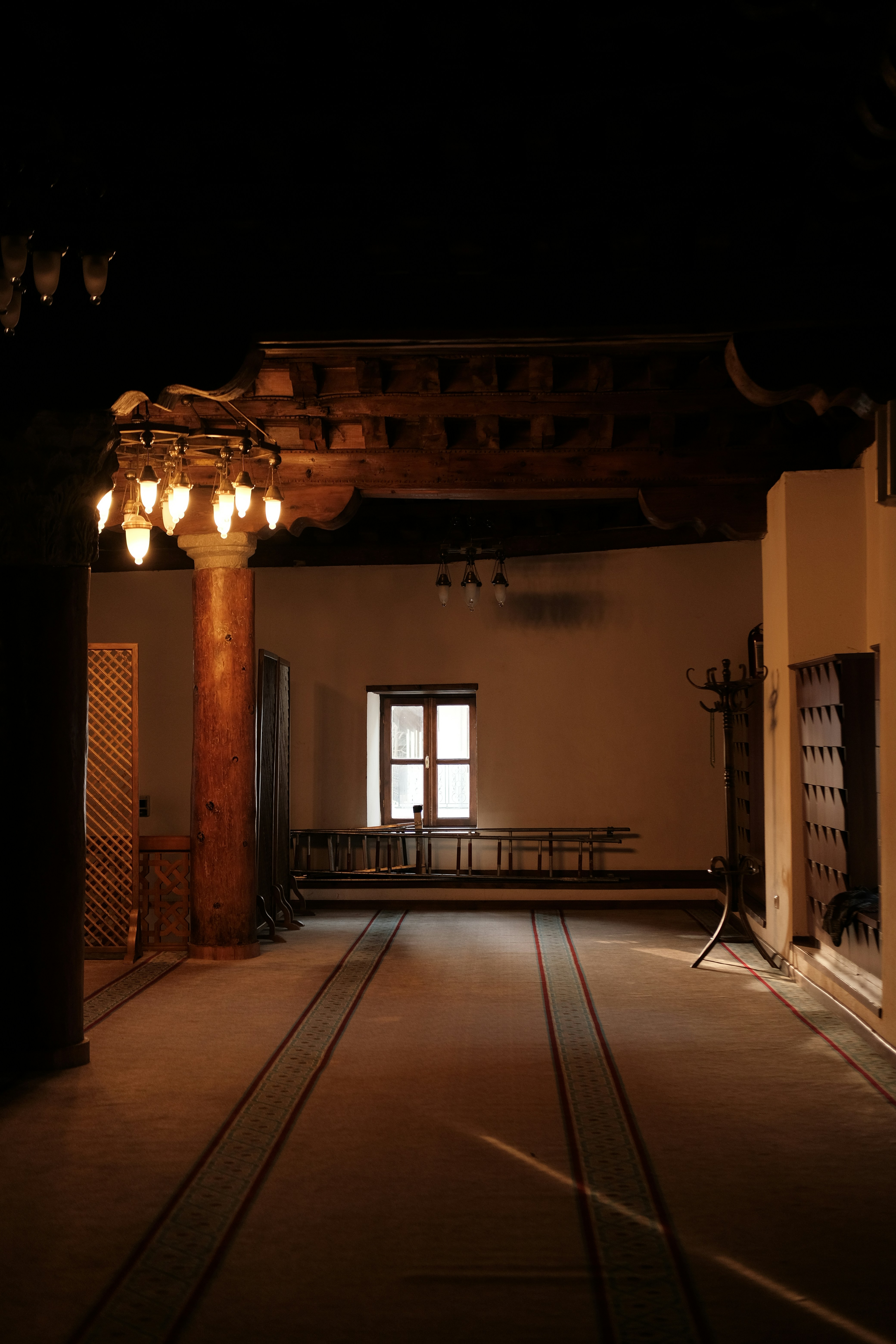 A dimly lit room with a table and benches photo – Free Interior design ...