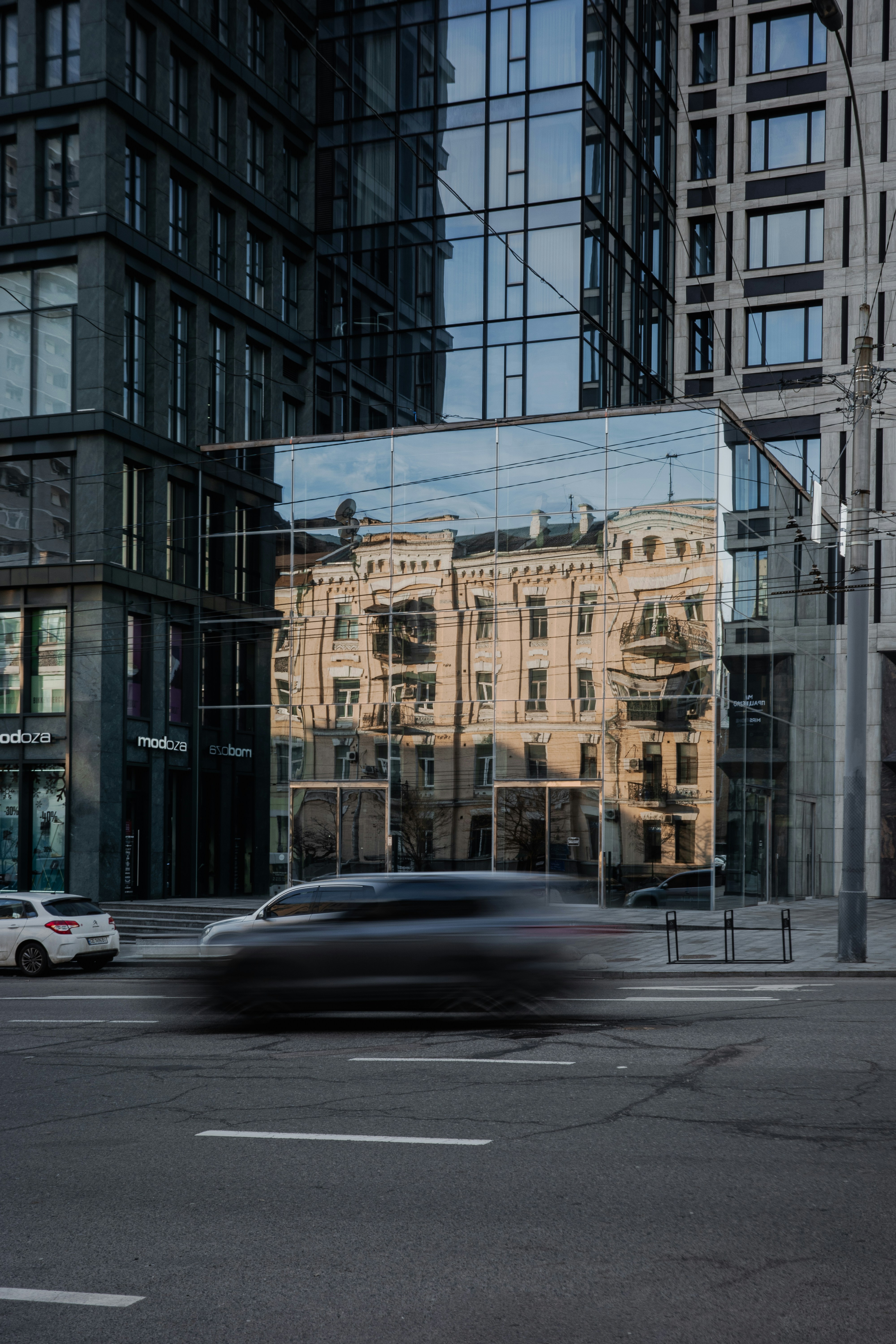 Reflected Facade in Motion: City Glass and Street Blur