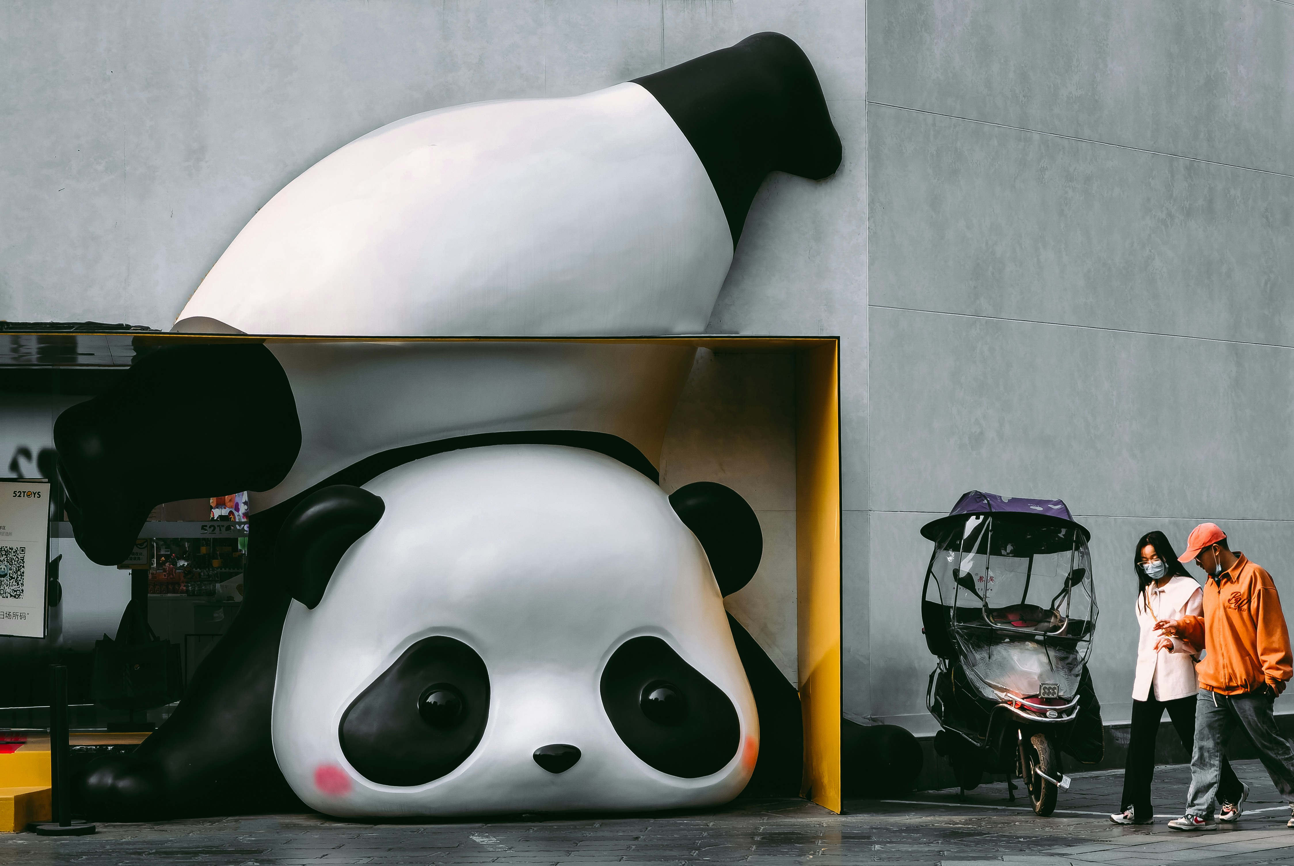 Giant Panda Lounging at a City Doorway: An Urban Sculpture in Curved Silence