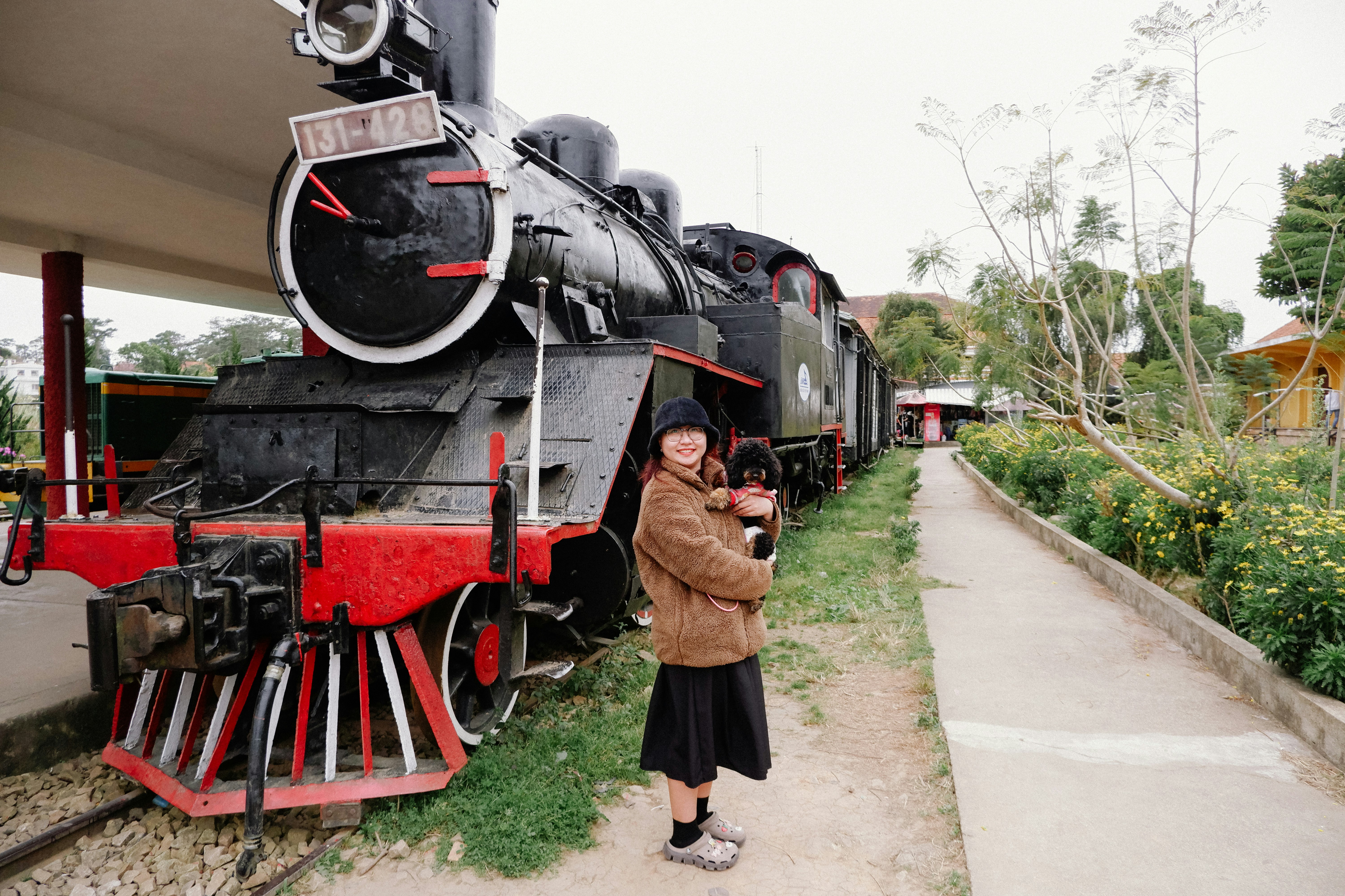 Warm Edge of Steel: A Woman and Her Dog by the Vintage Locomotive