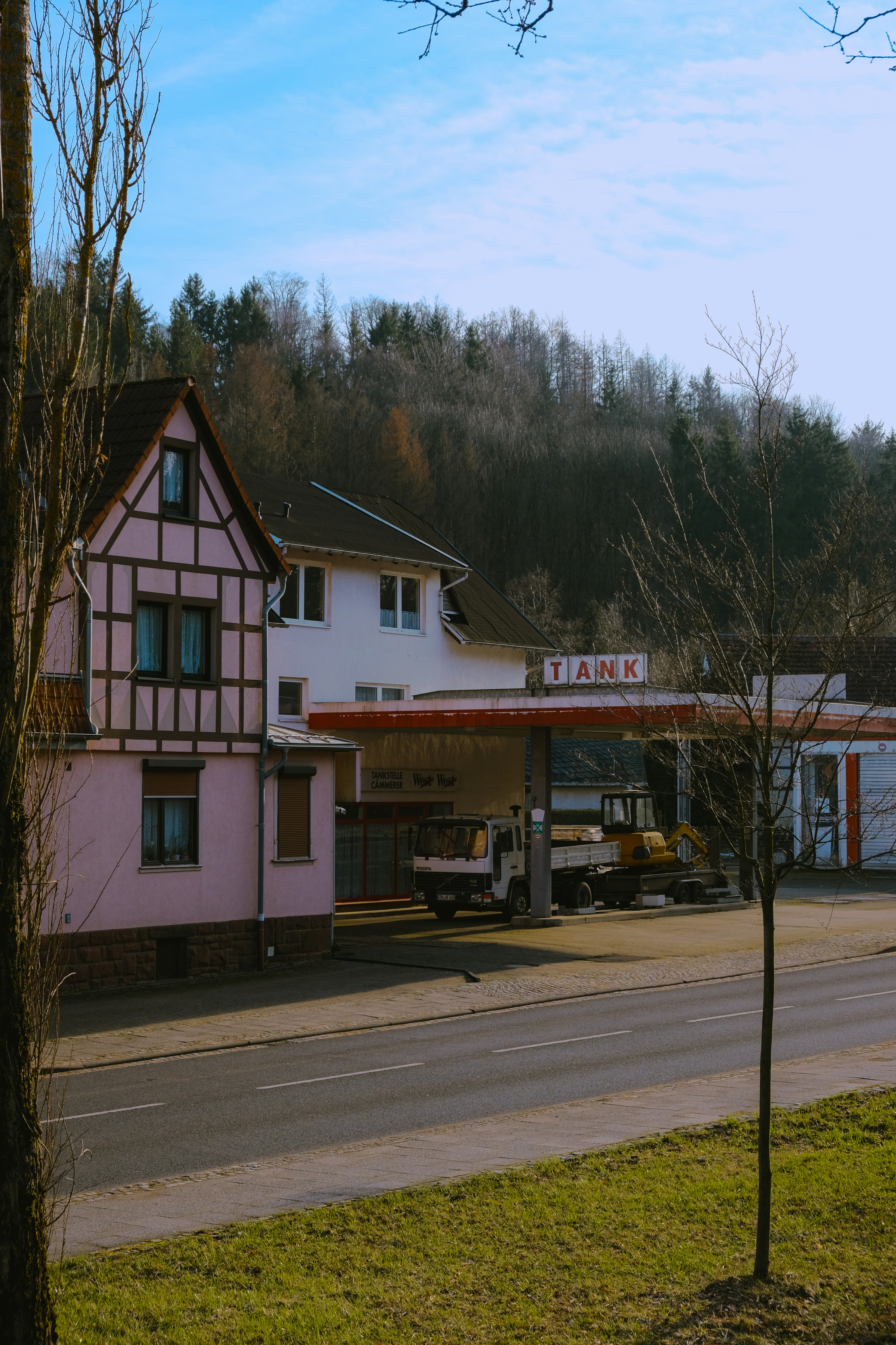 Pastel-Timbered House by a Quiet Gas Stop