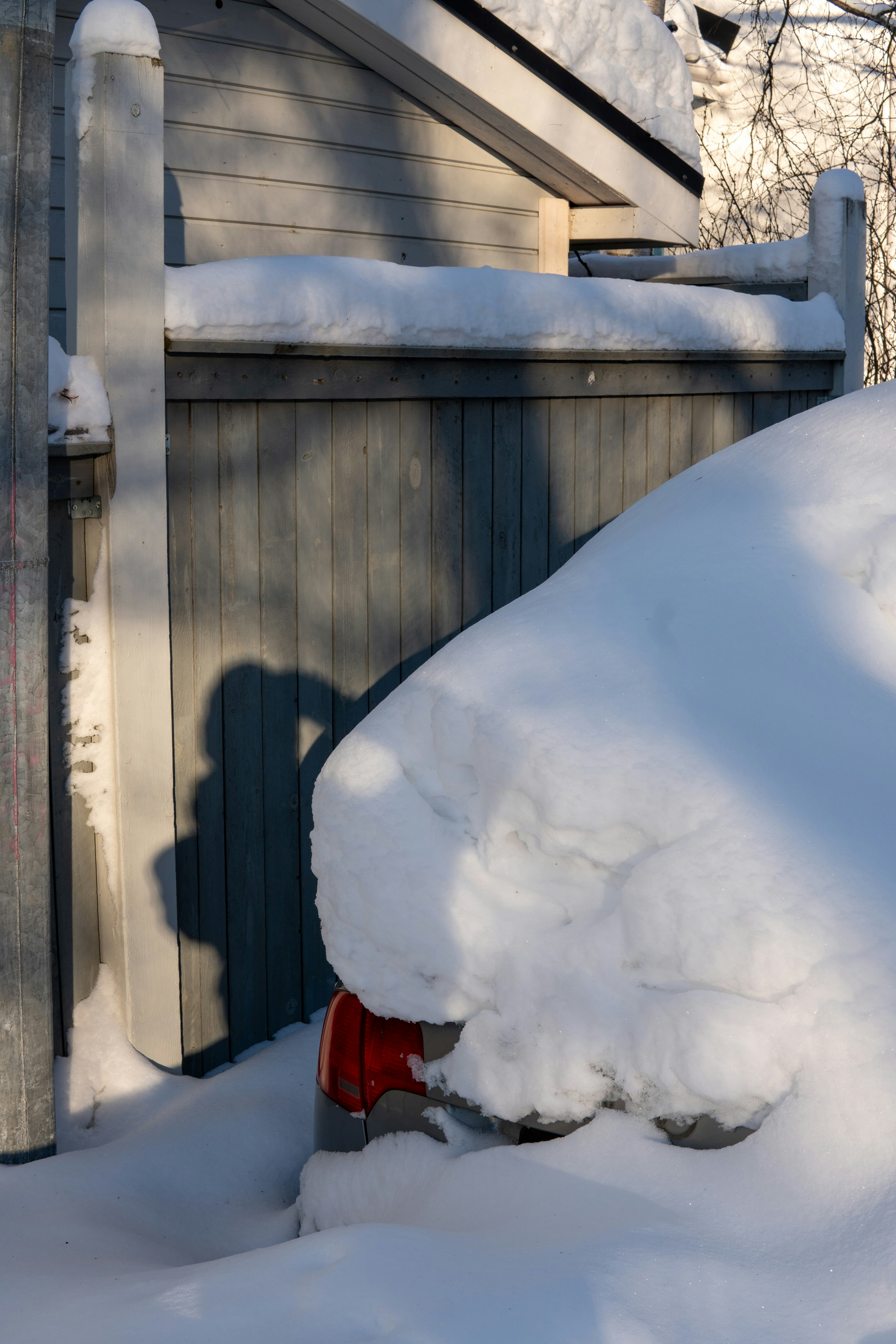 A red fire hydrant covered in snow next to a building photo – Free ...