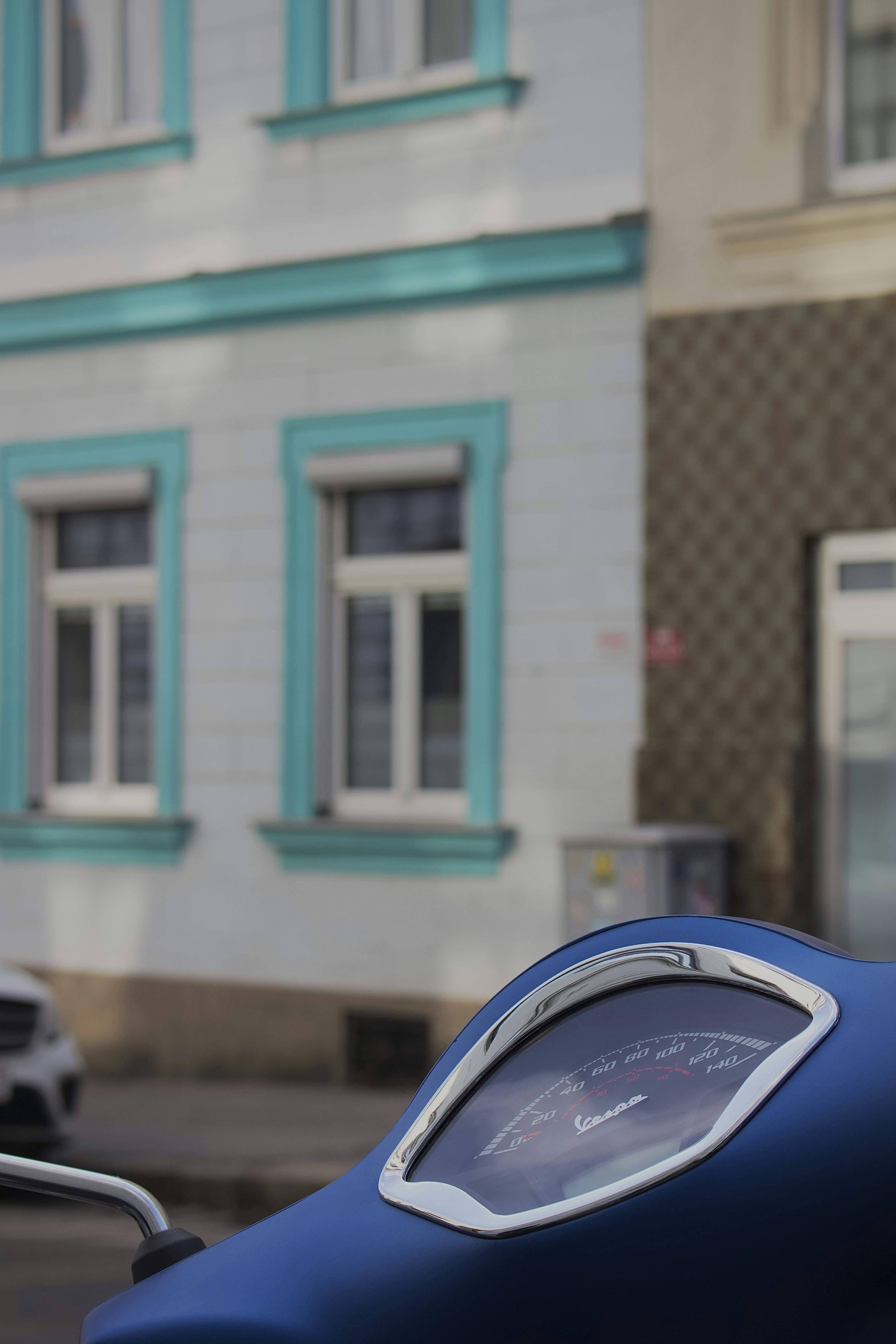 Blue Scooter Framing the Street: A Quiet Urban Moment