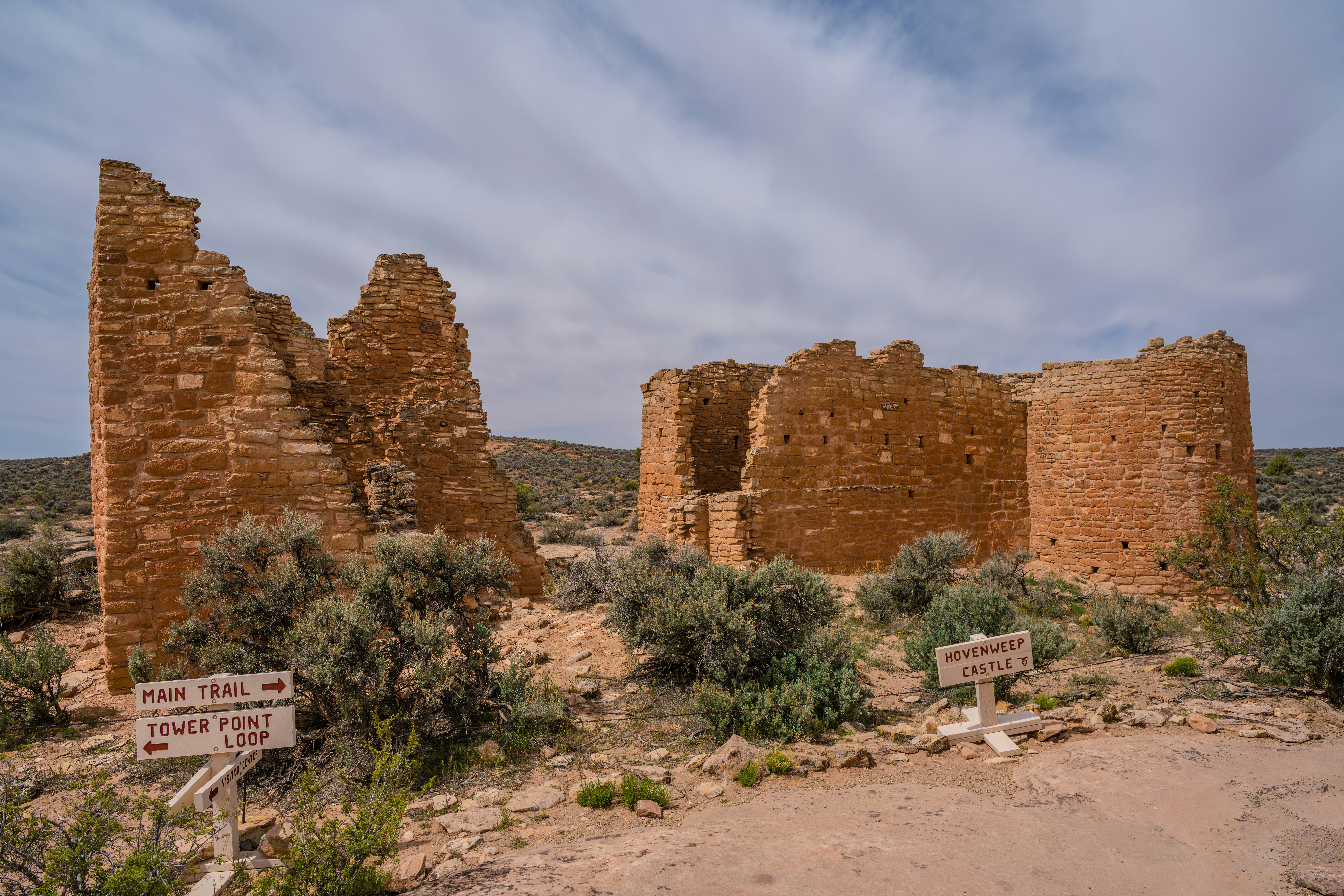 A couple of signs sitting on the side of a dirt road photo – Free ...