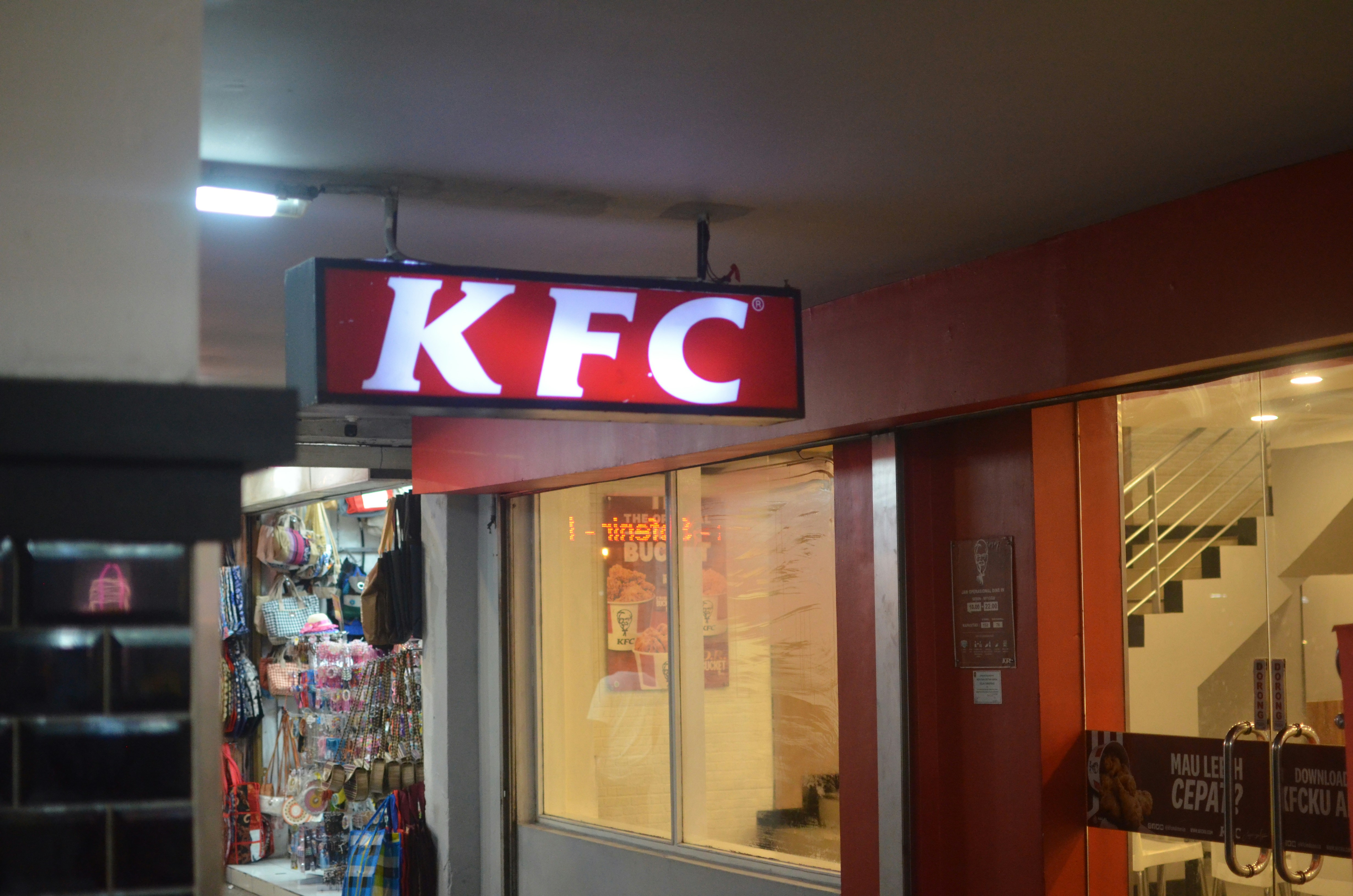 A kfc sign hanging from the side of a building photo – Free Indonesia ...