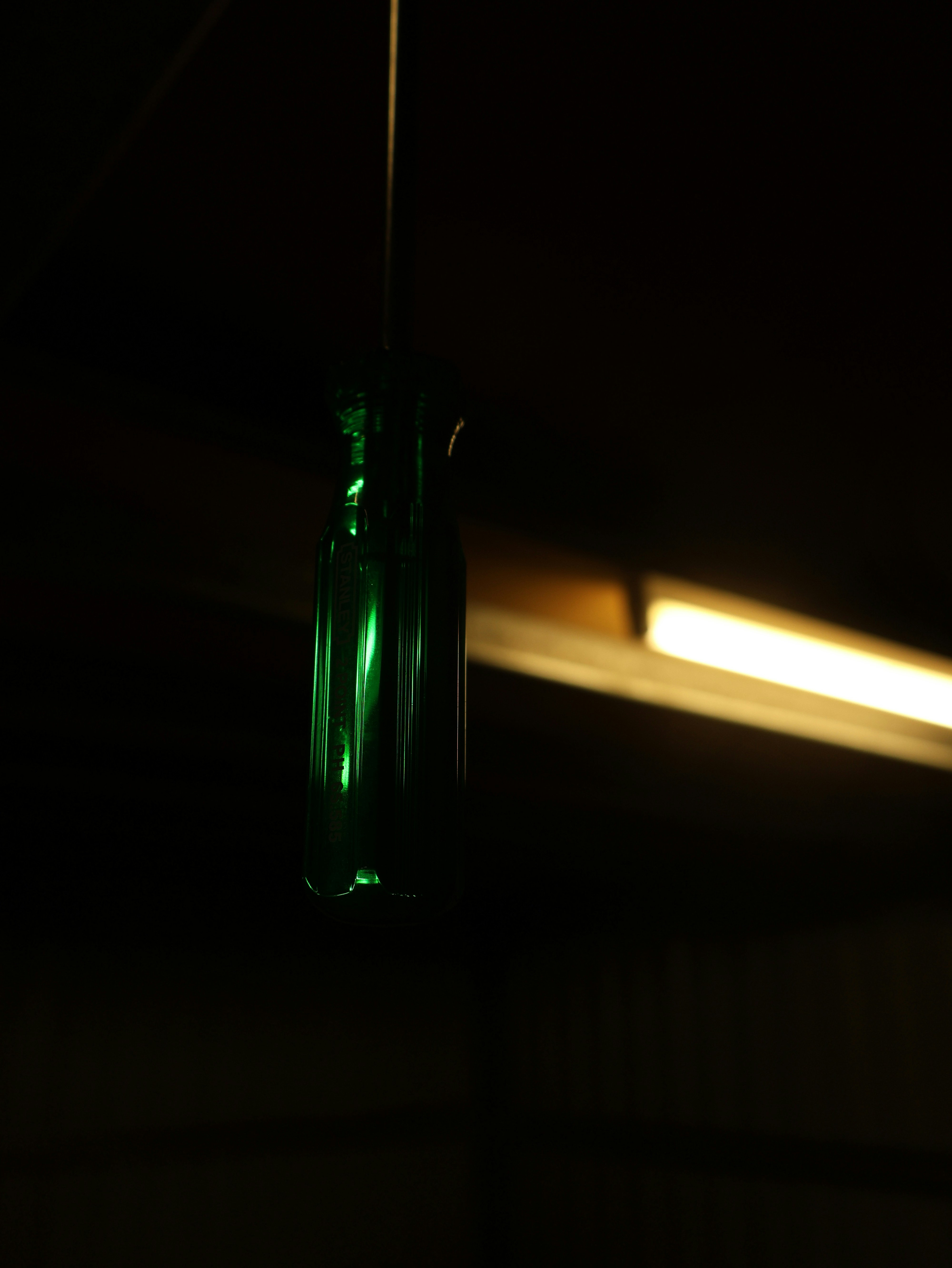 Emerald Pendant in a Dim Workshop