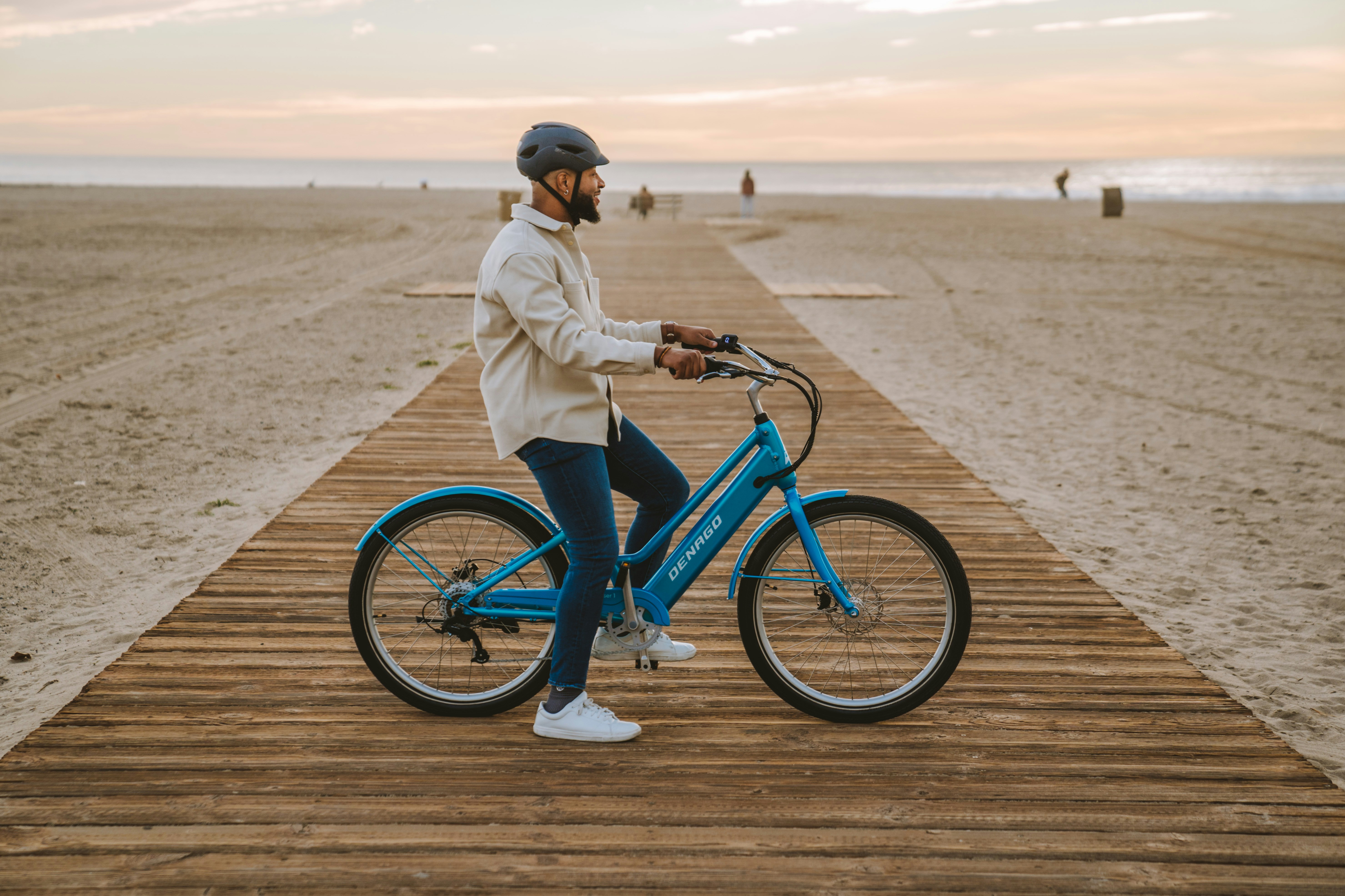 A man riding a blue bike on a boardwalk photo – Free Ebikes Image on Unsplash