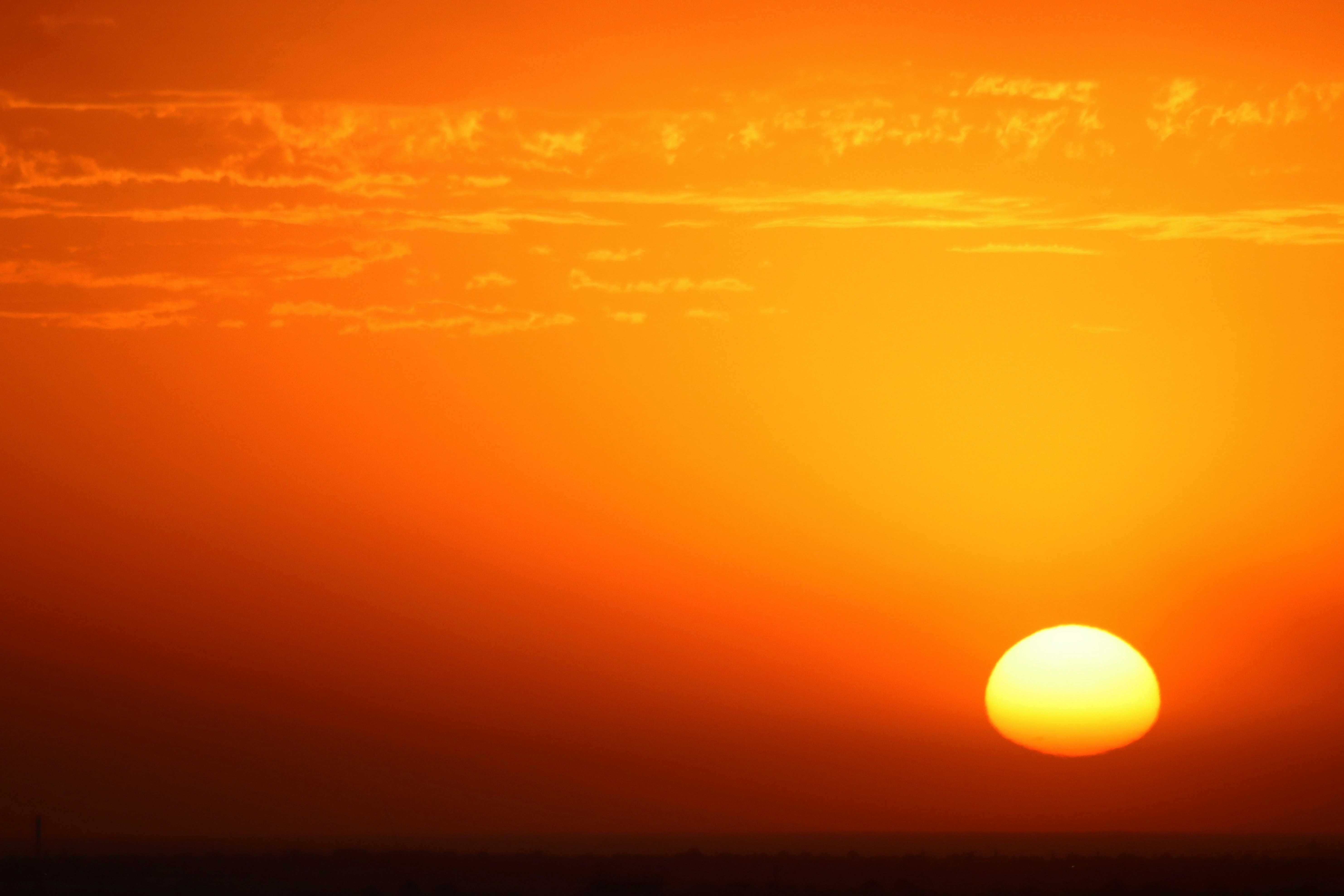 The sun is setting over the horizon of the ocean photo – Free Sunset ...