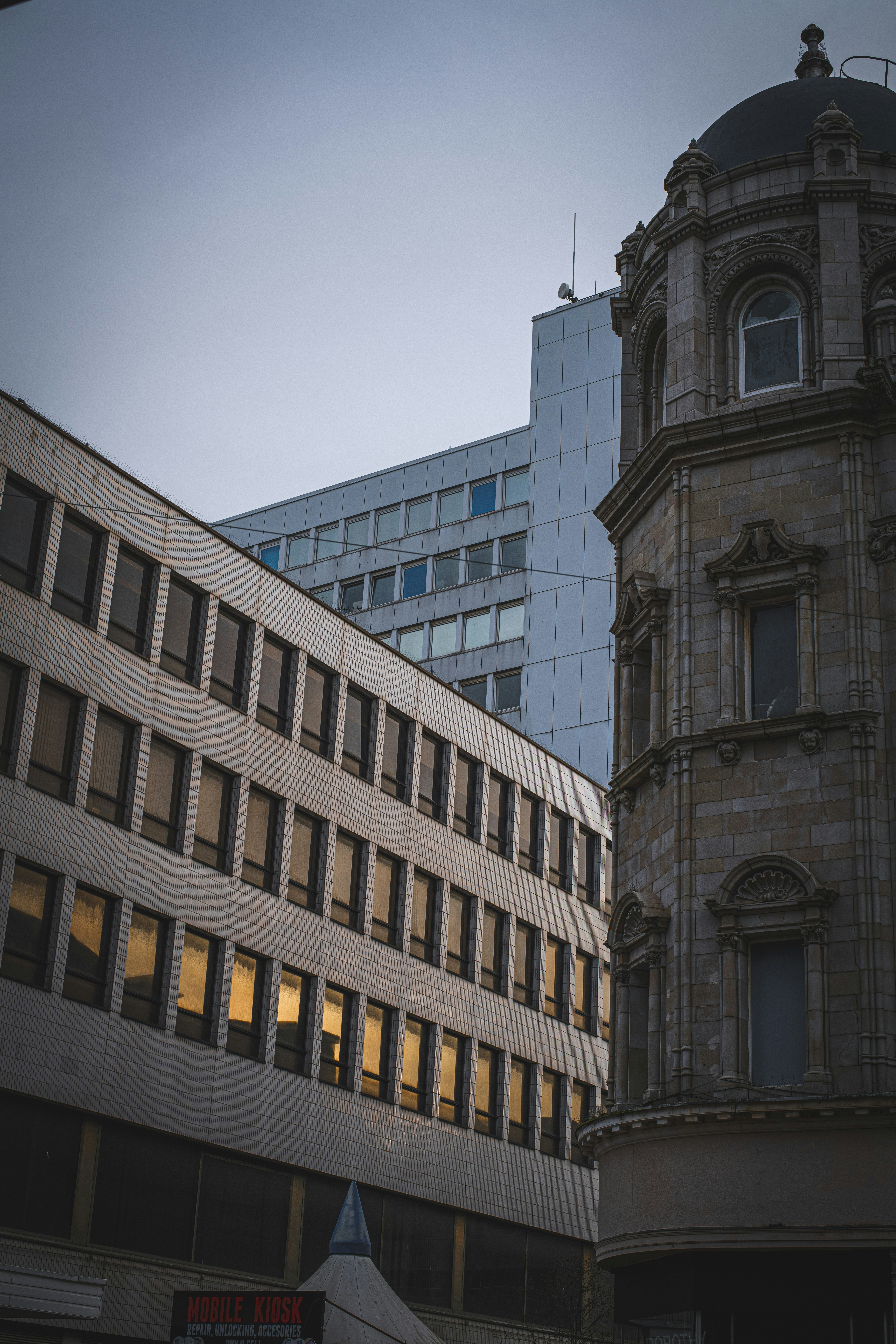 Corner of Time: Stone Turret Meets Glass Facade