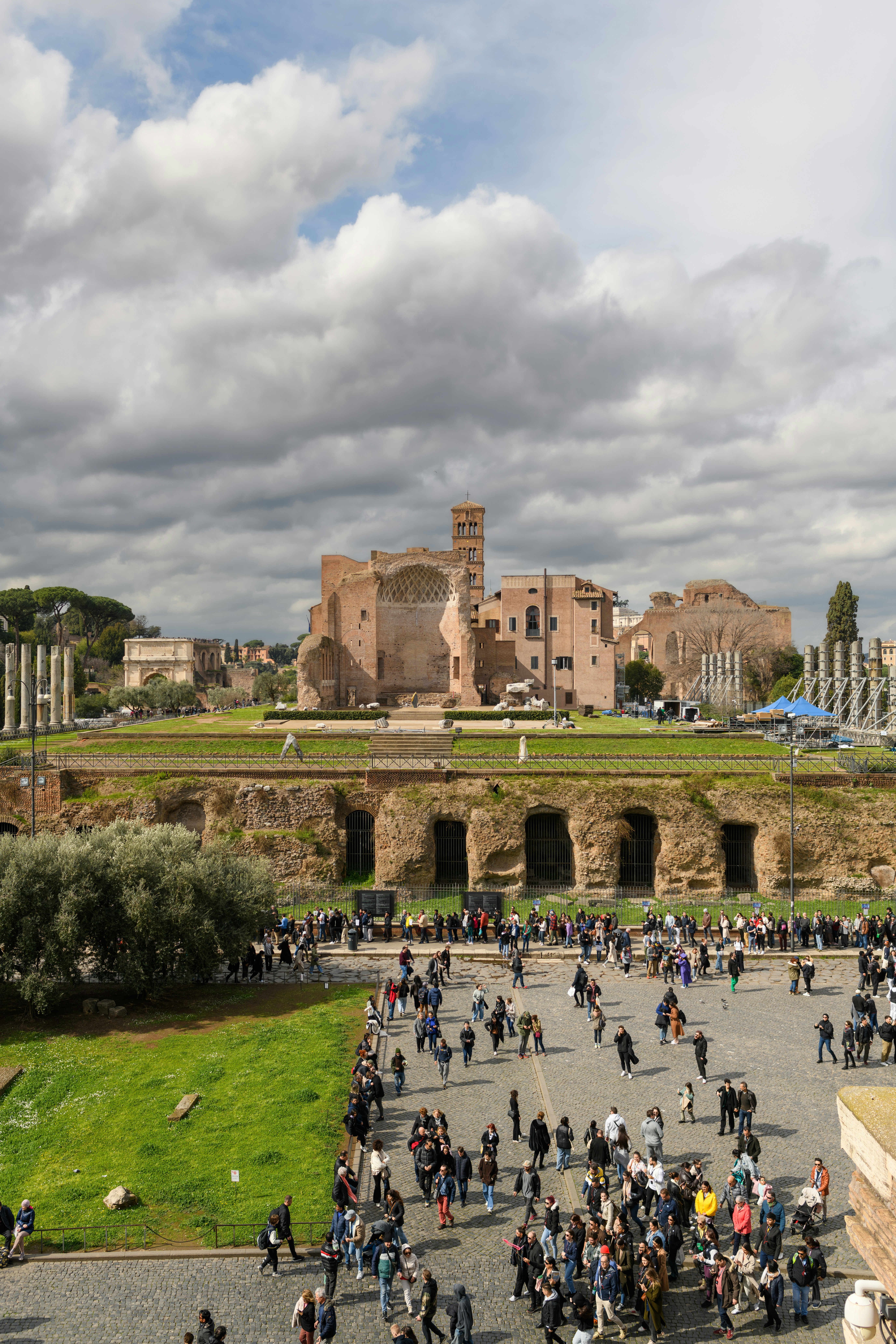 Ancient Forum Ruins and a Crowd Under a Moving Sky