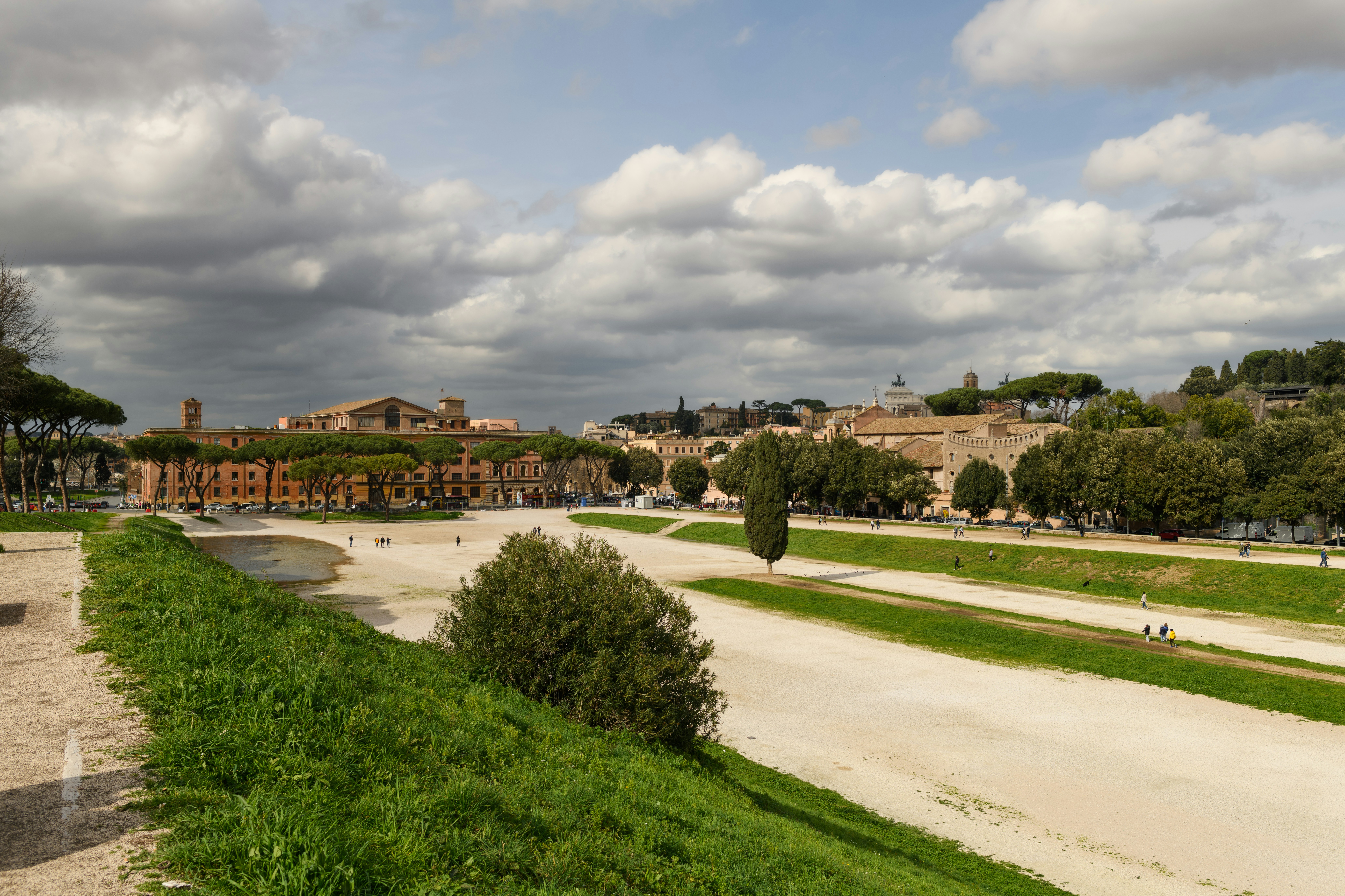 Cloud-stitched Calm: Ancient Ramparts Framing a Sunlit Roman Park