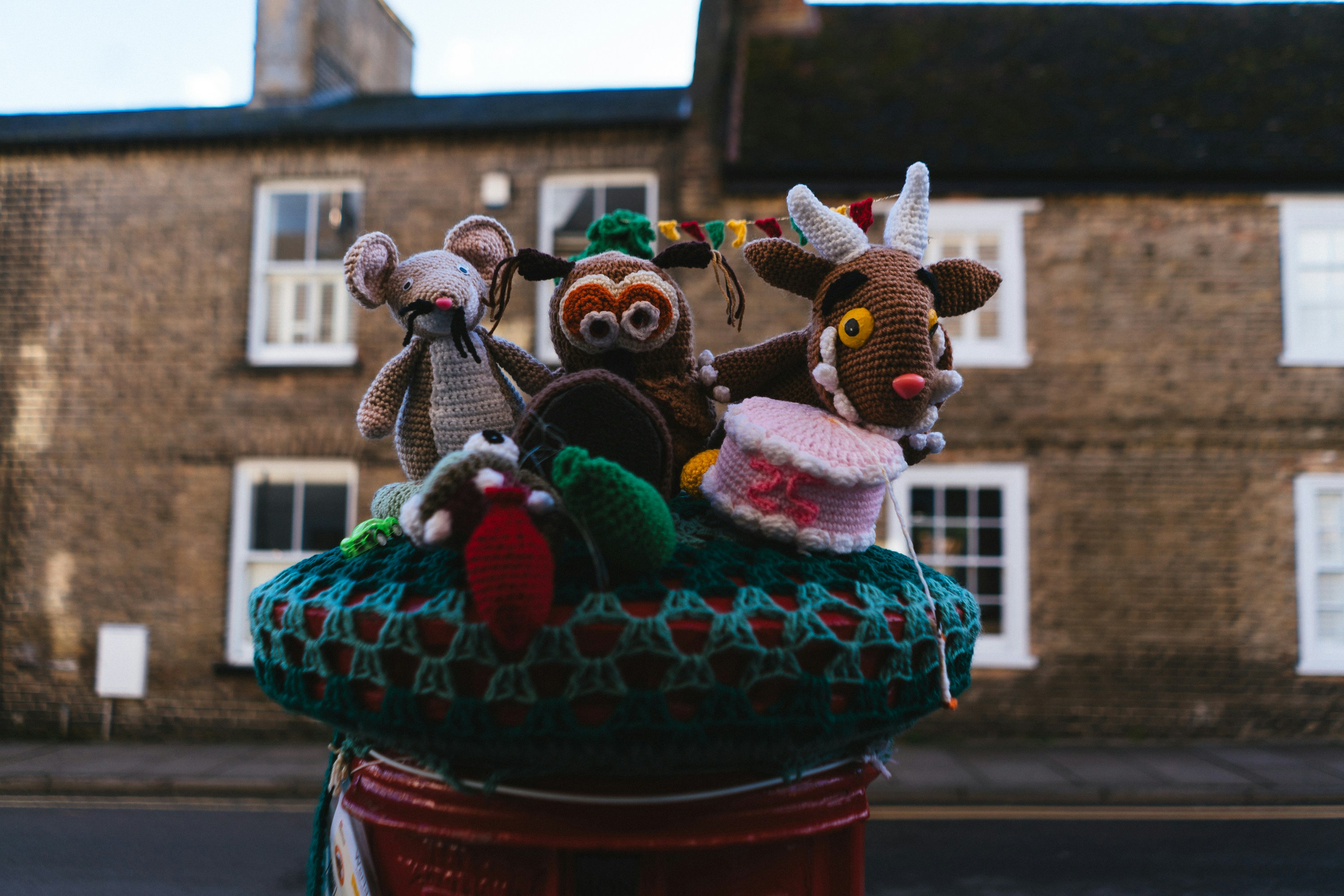 A group of stuffed animals sitting on top of a fire hydrant photo ...