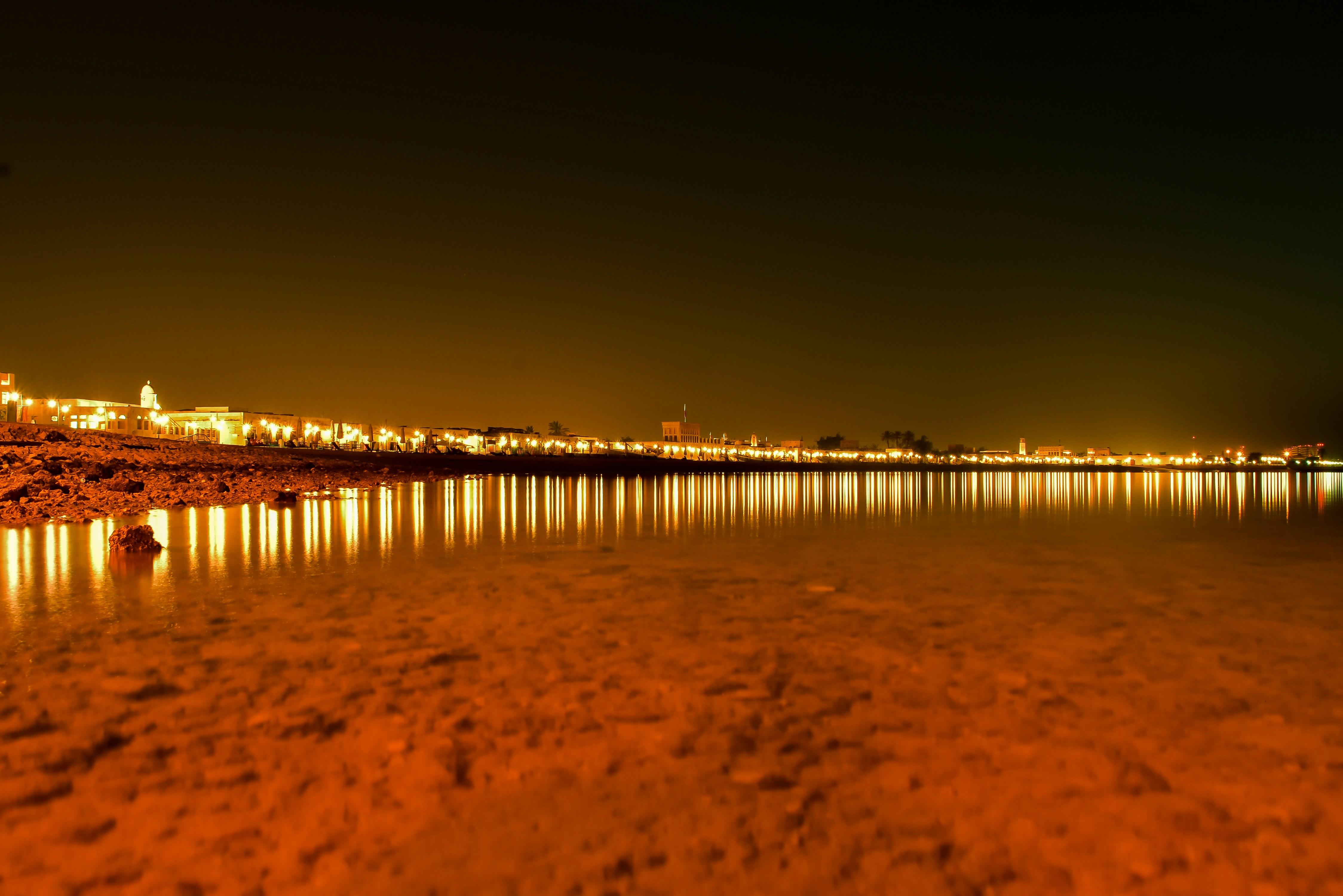 A body of water with a city in the background photo – Free Wakra family ...