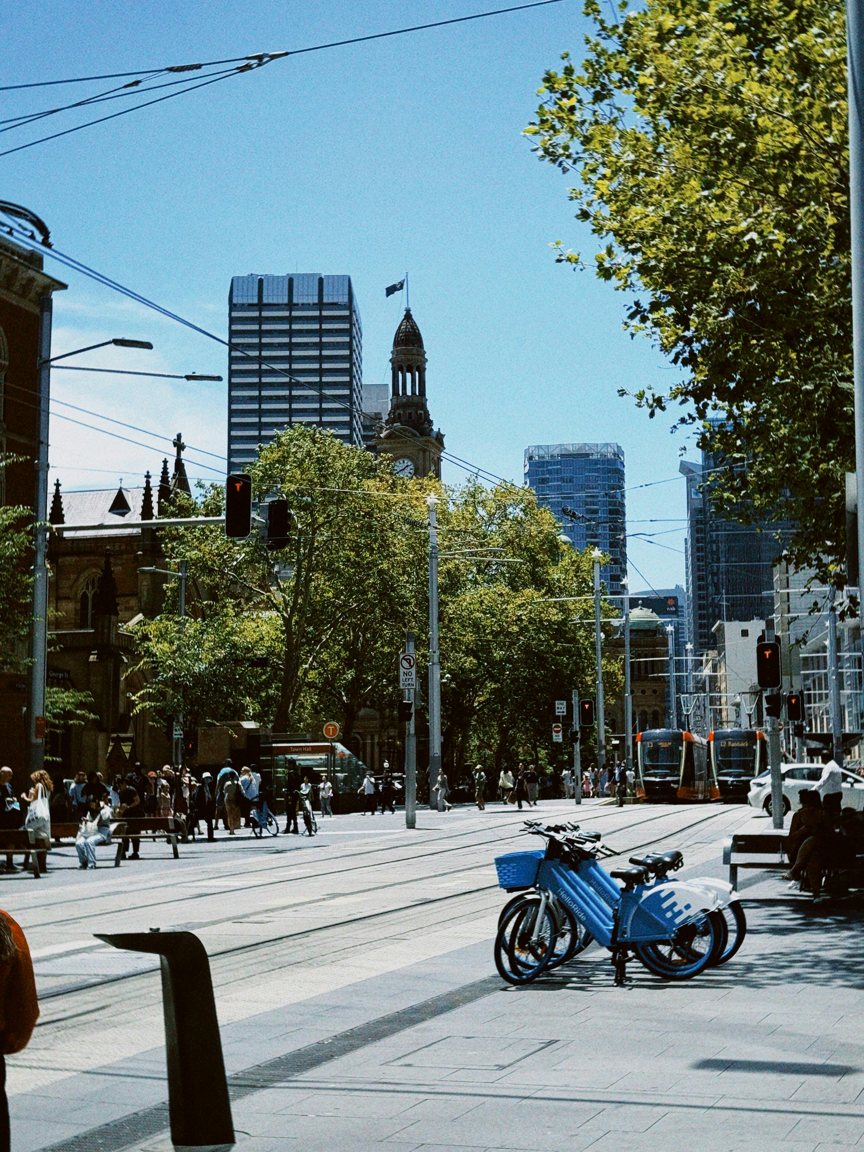 Blue Rental Bike Anchors a Sunlit Tram-Track City Scene