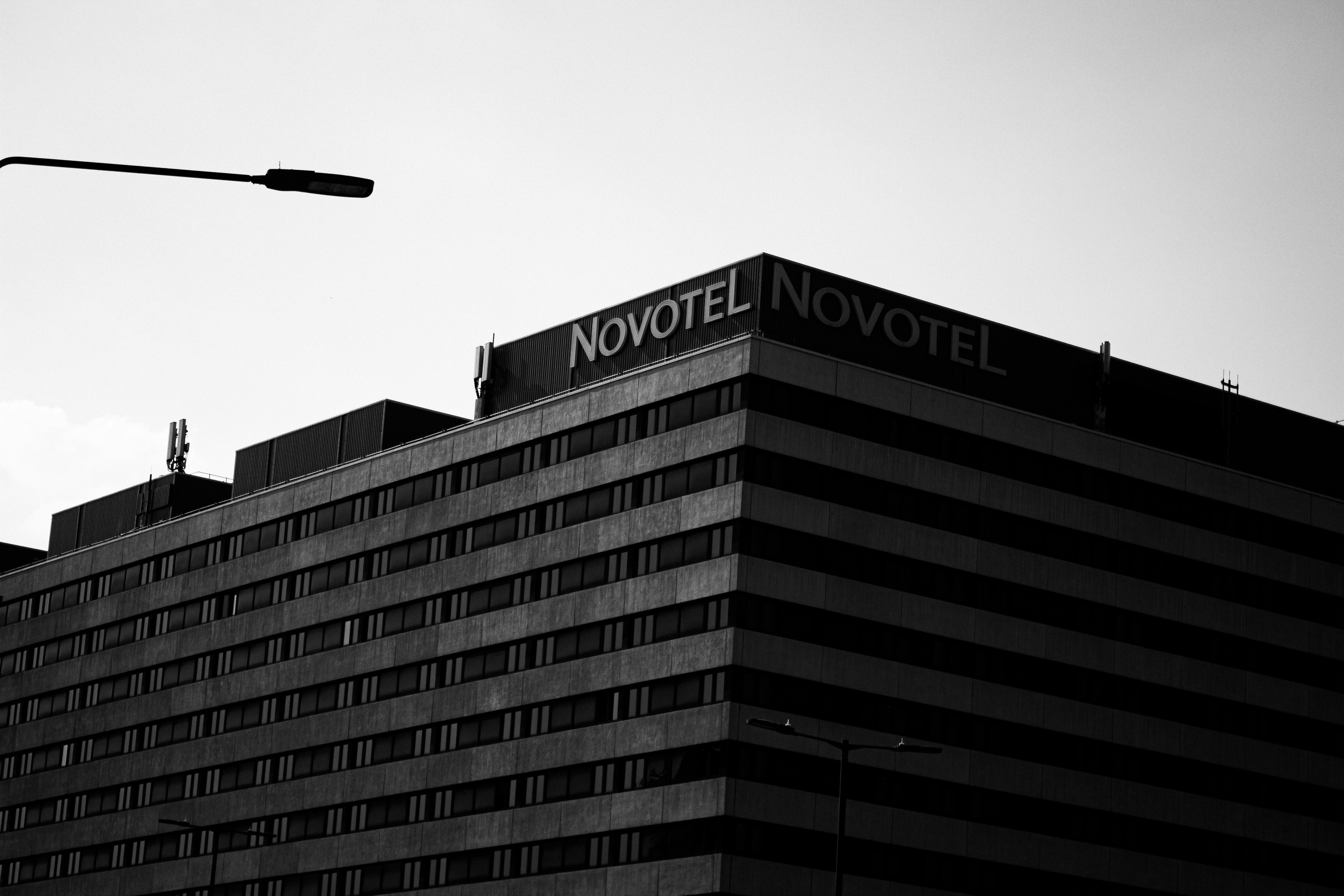 a black and white photo of a building and a street light