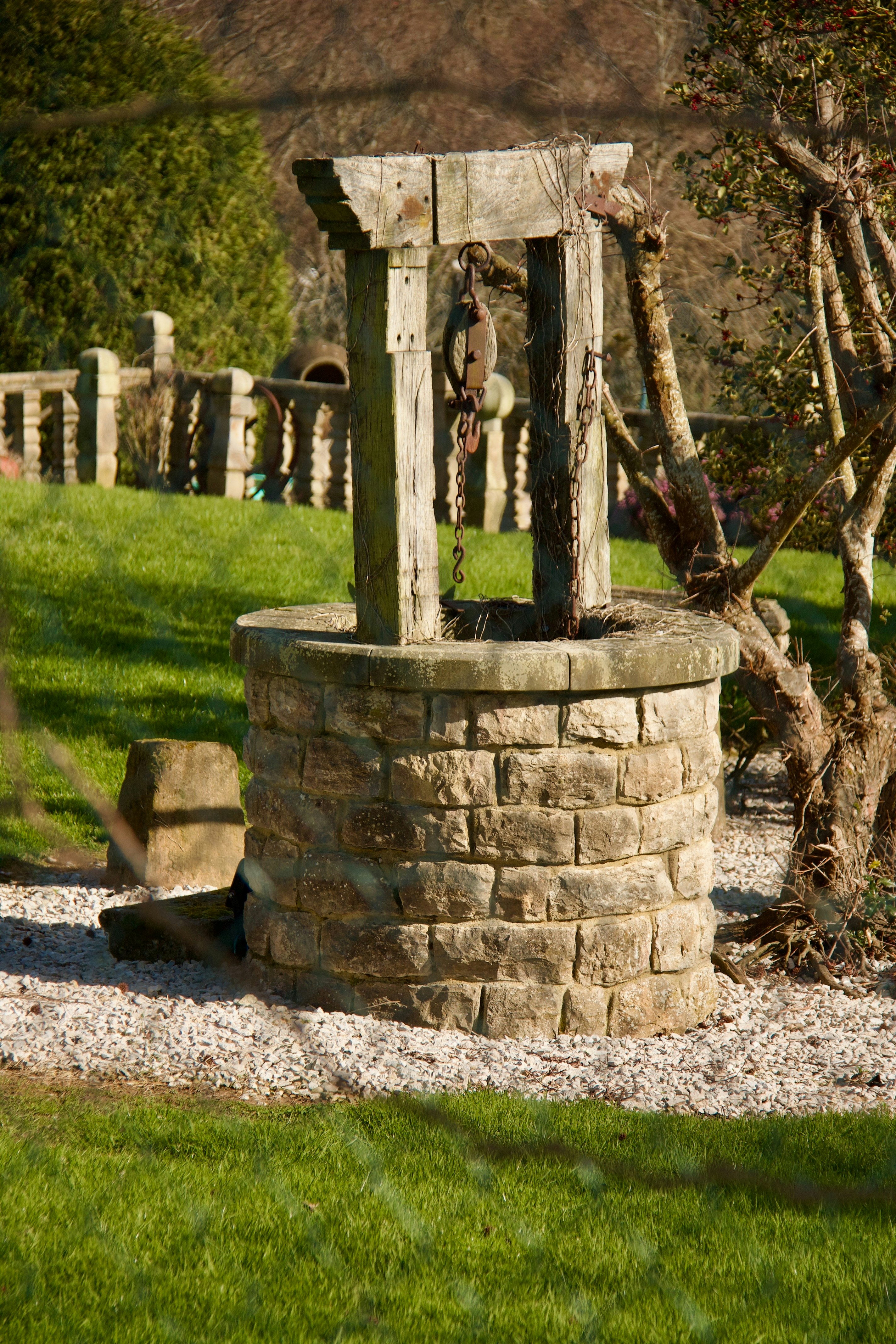 Weathered Stone Well in a Sunlit Garden