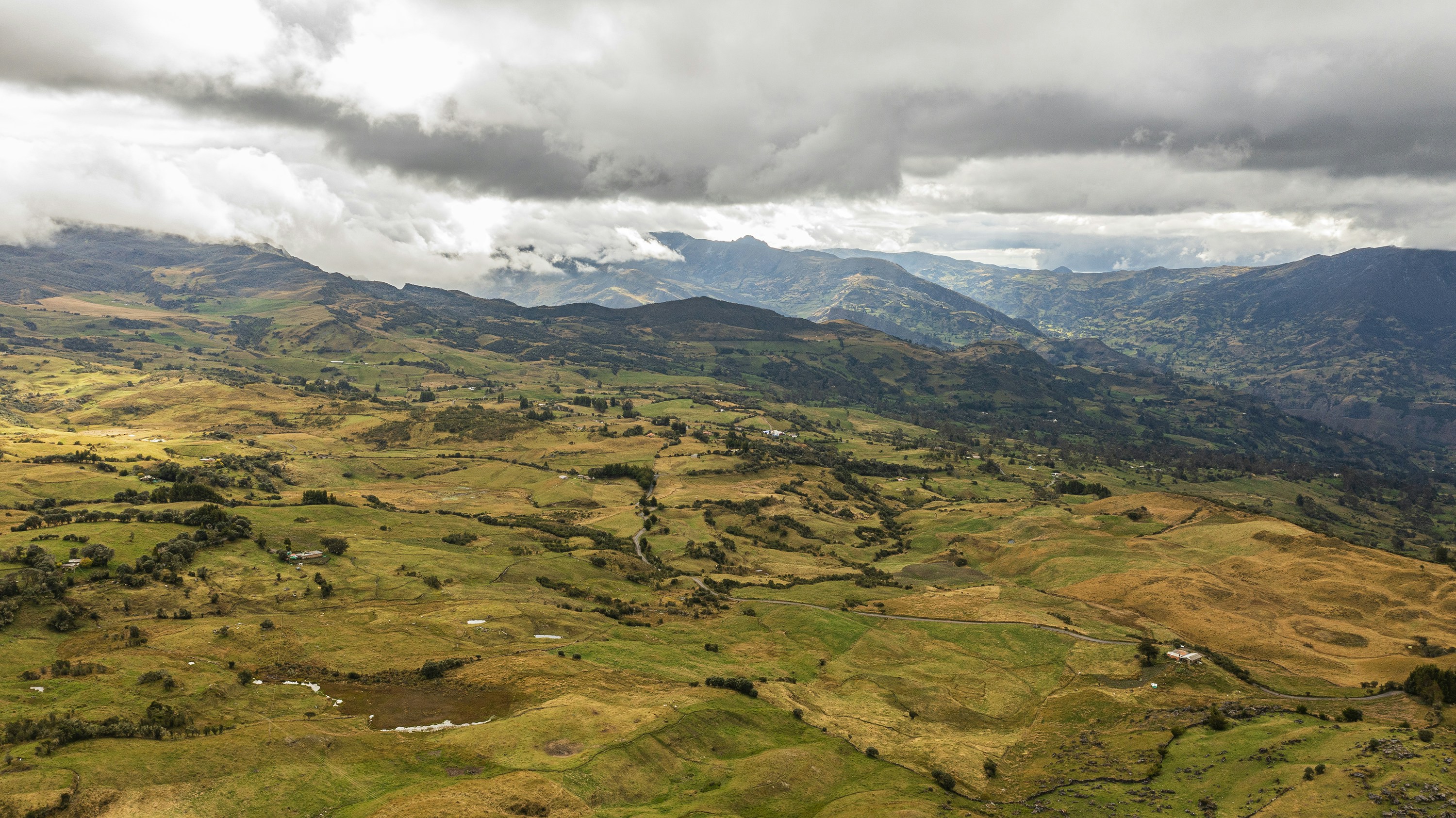 An aerial view of a valley with mountains in the background photo ...
