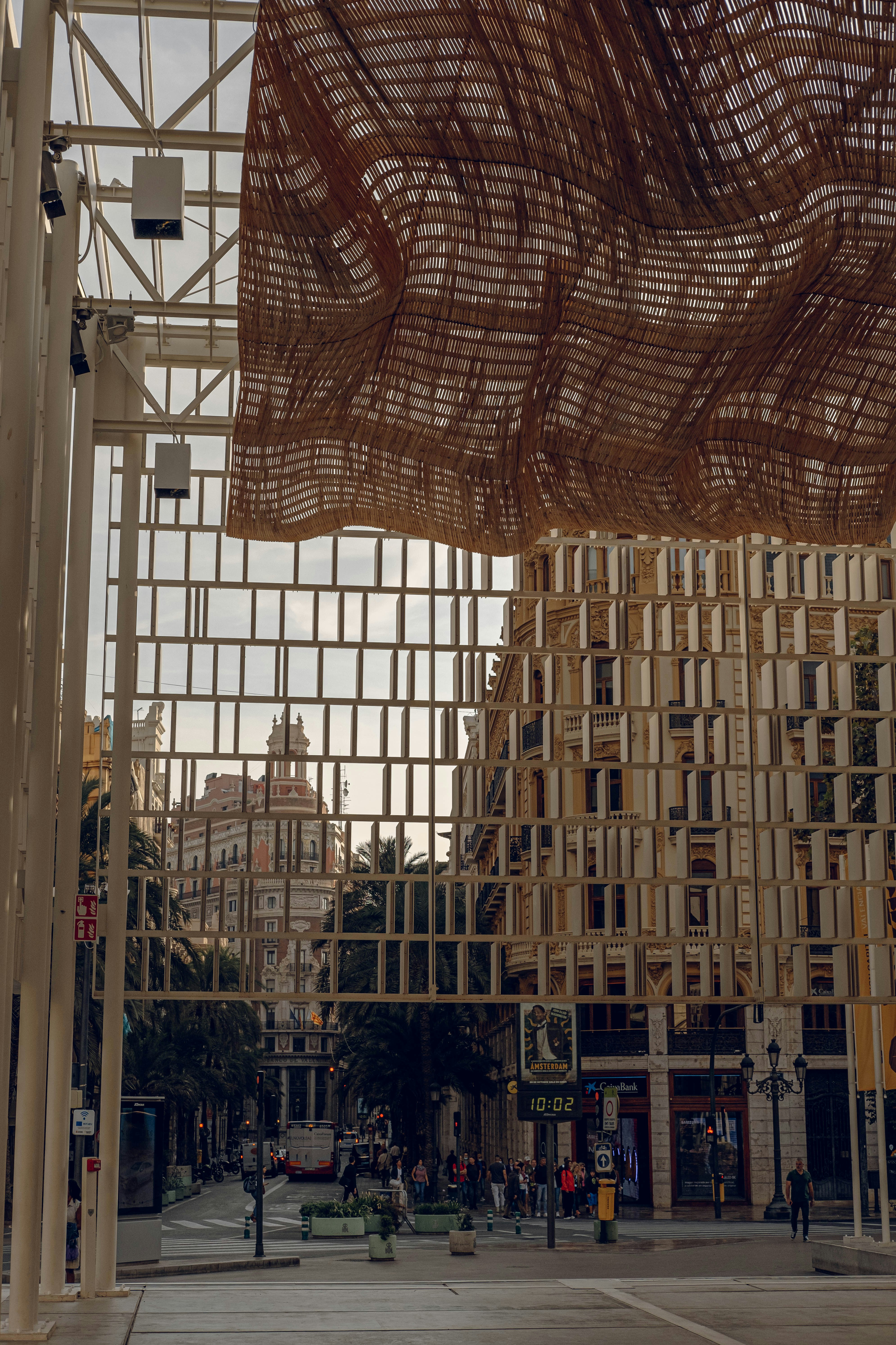 Threads of Shade Over a Grid-Lined City Plaza