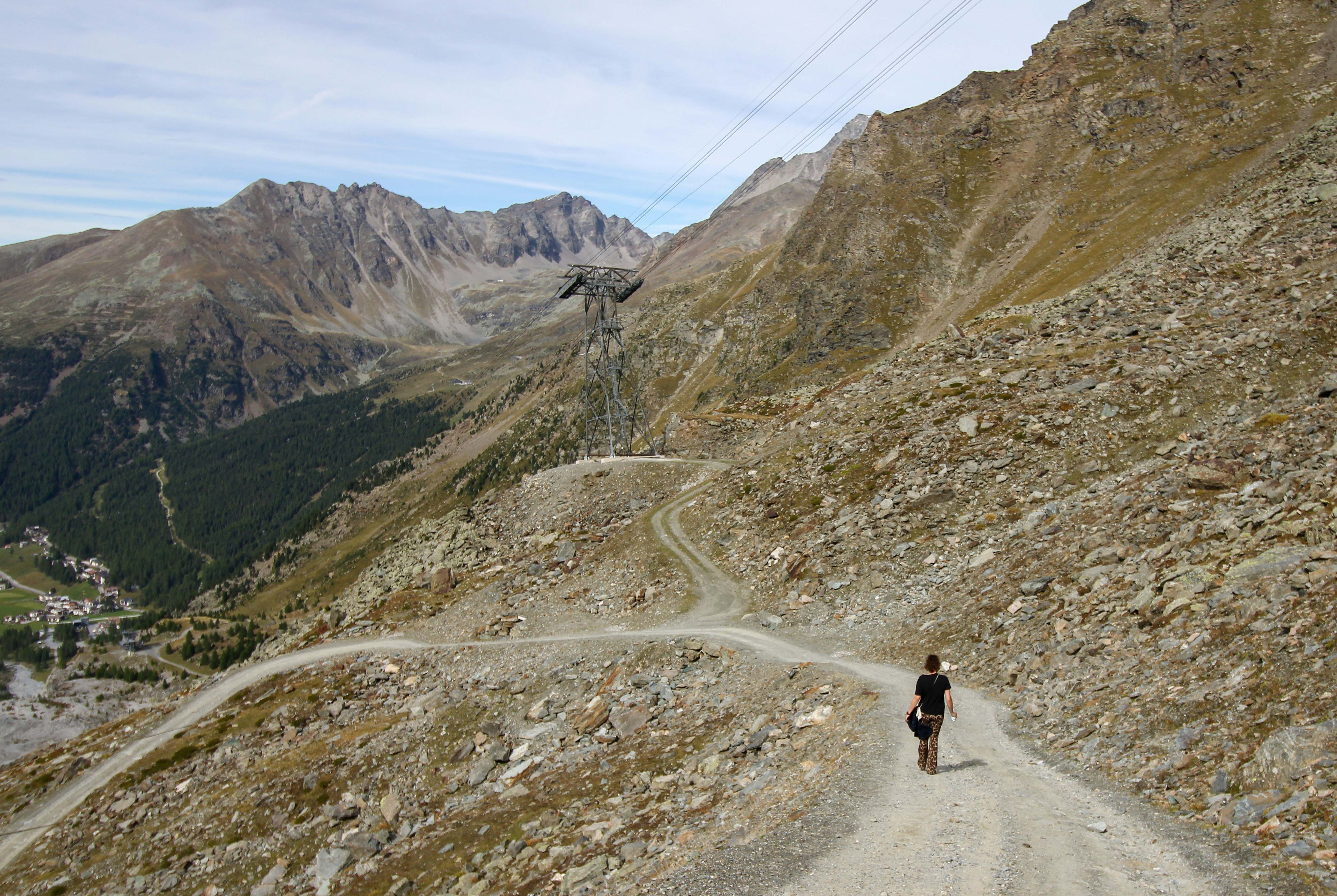 A person walking down a dirt road in the mountains photo – Free Human ...