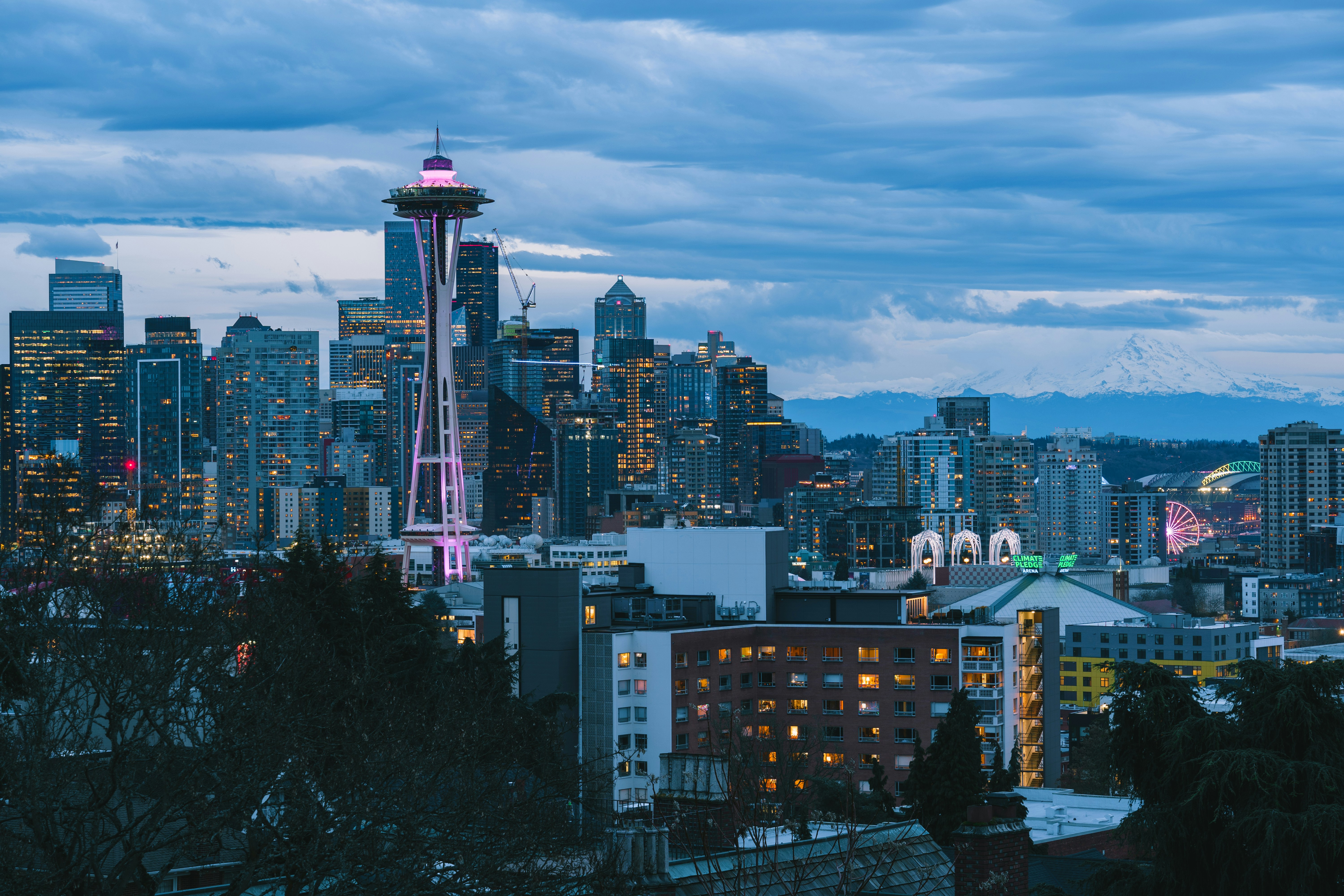 Pink-lit Space Needle crowns Seattle's blue-twilight skyline