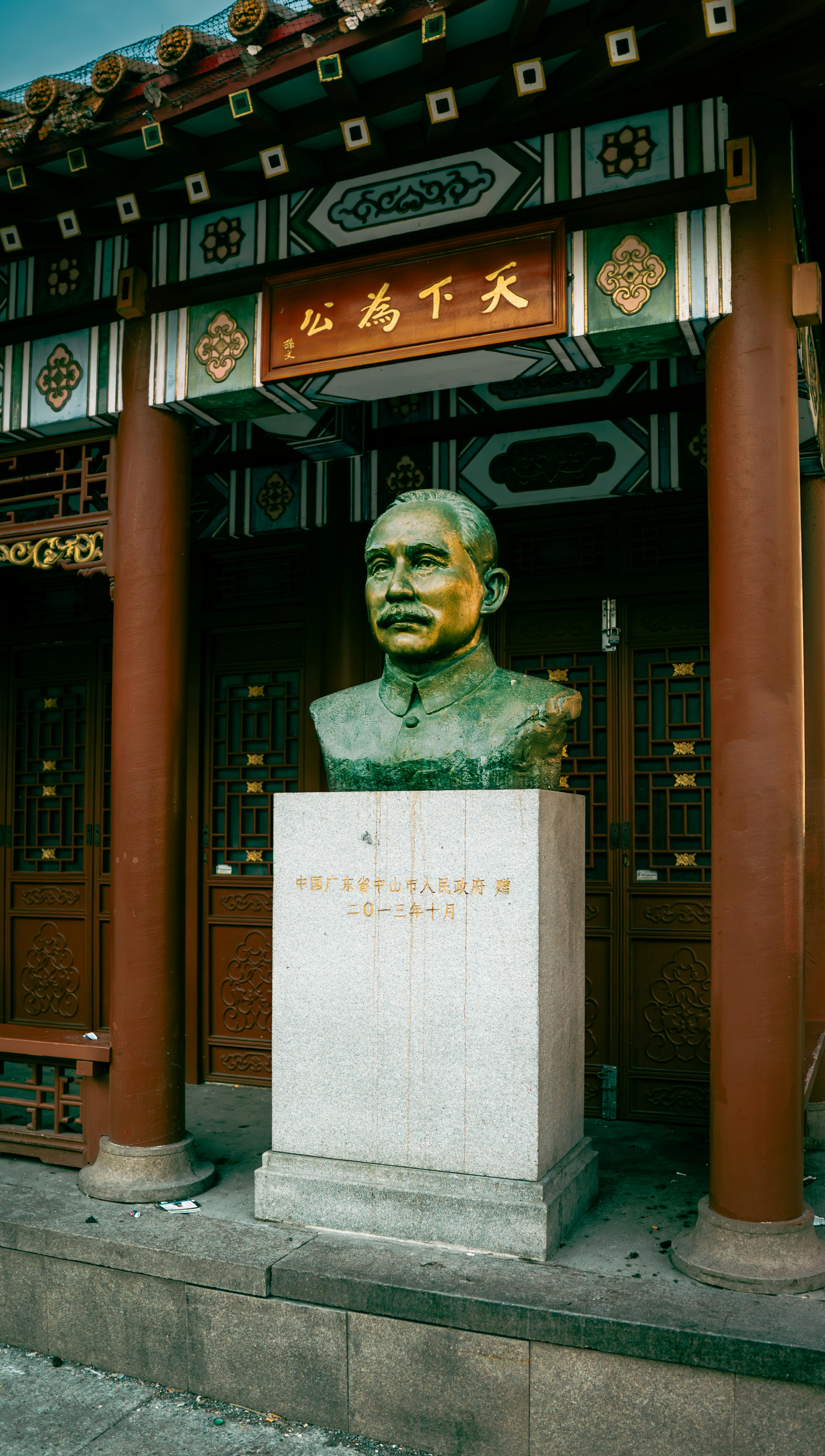 Bronze Bust Anchored by a Painted Chinese Temple Gate