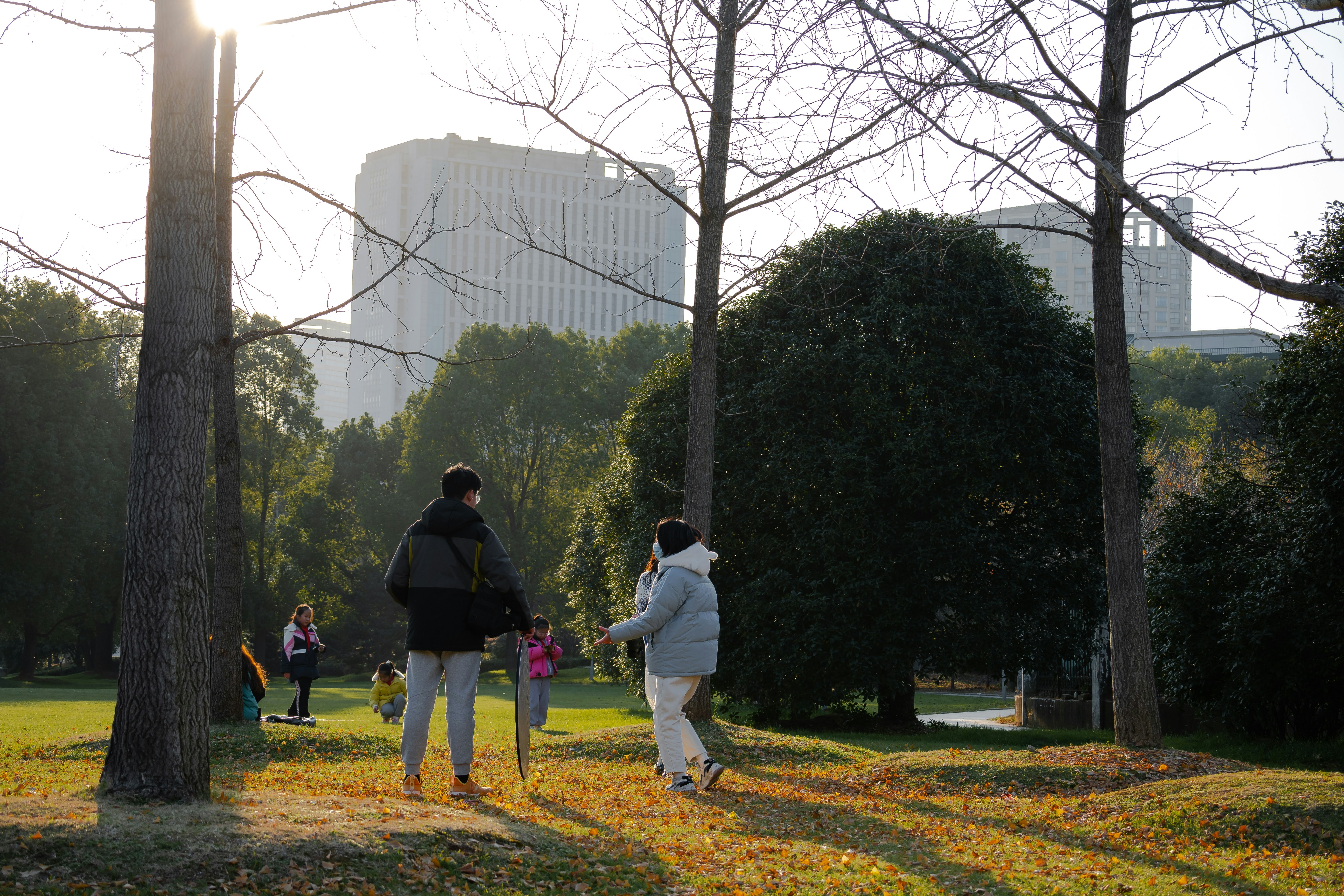 A group of people walking through a park photo – Free China Image on ...