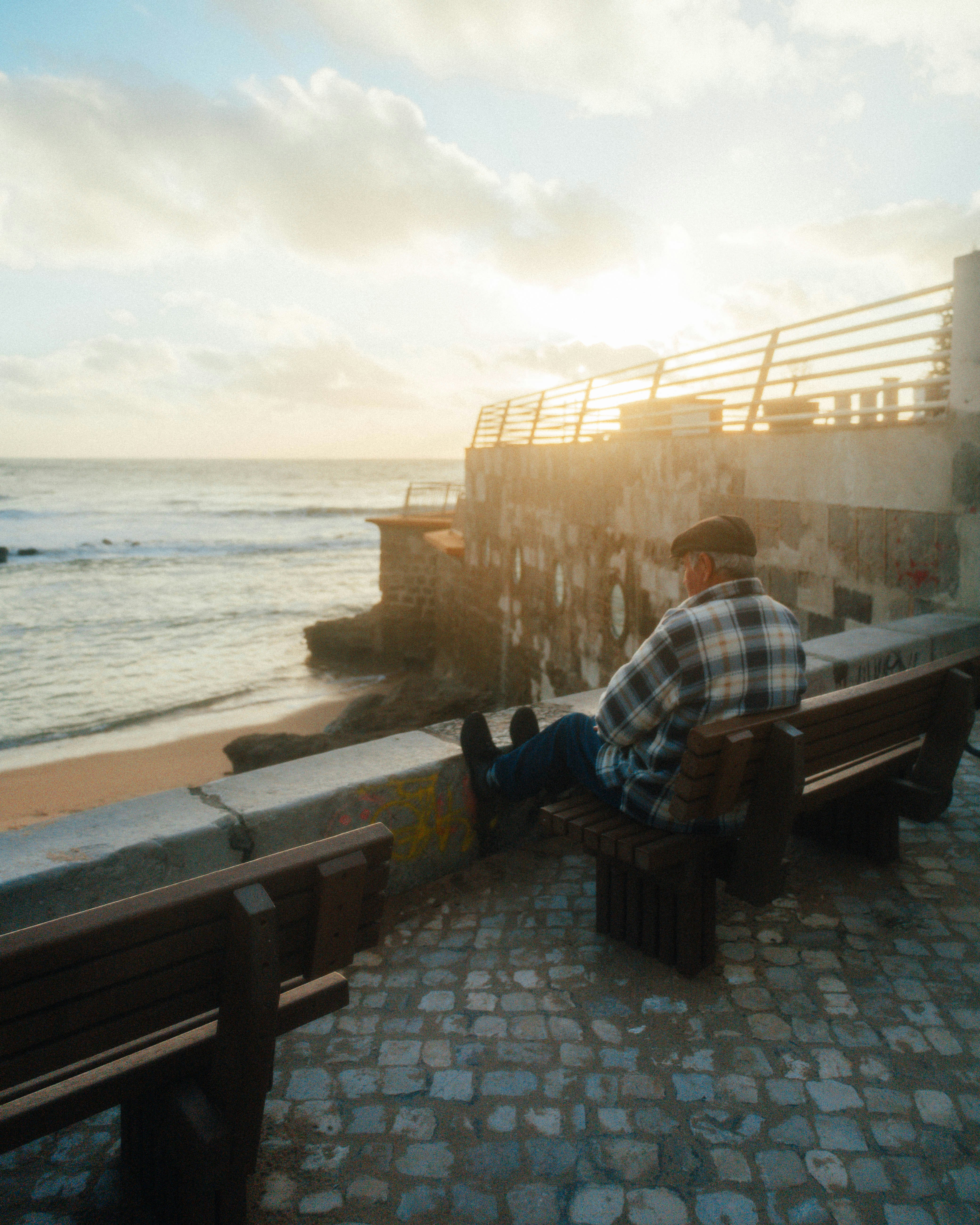 Sunset Benchkeeper: A Quiet Moment by the Sea