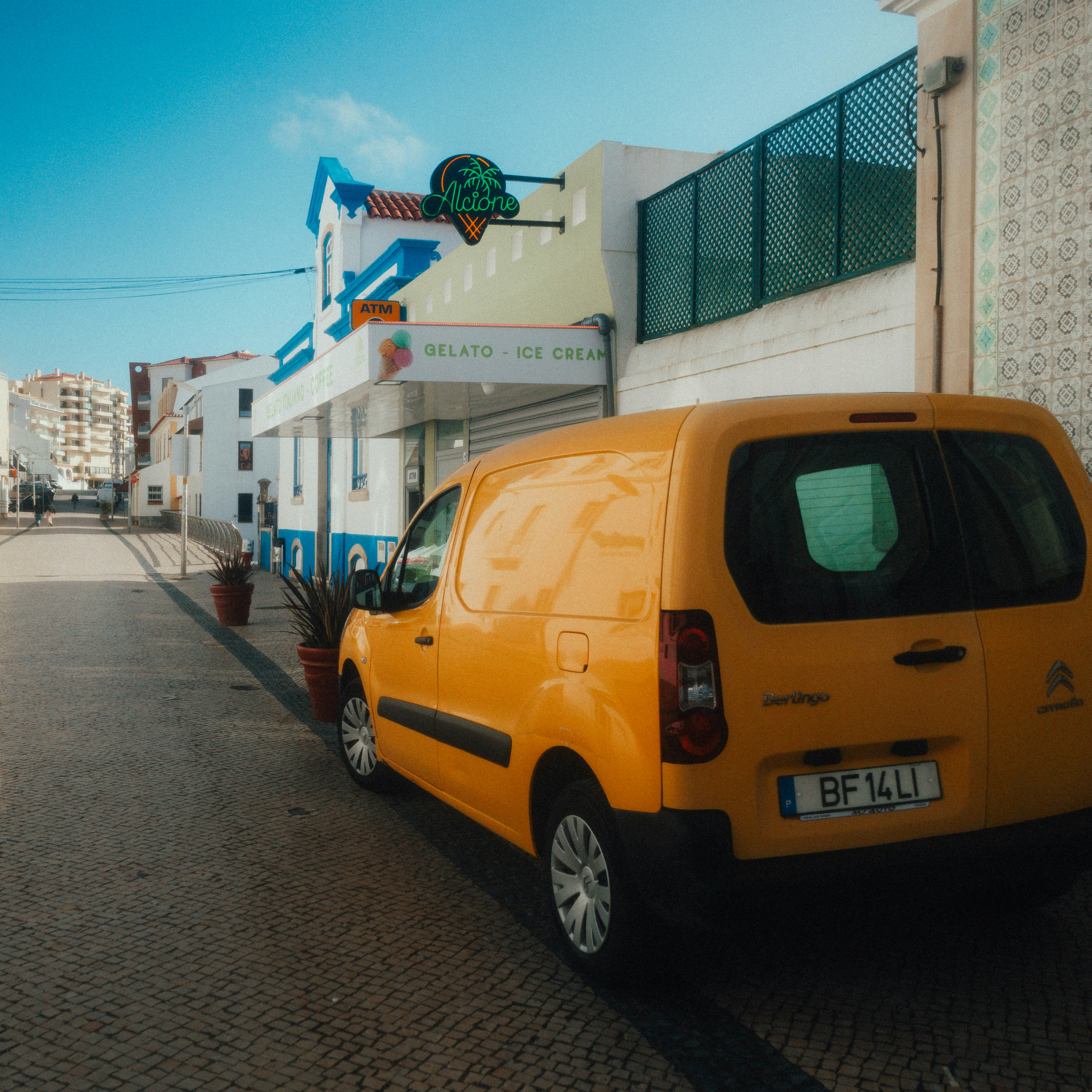 Bright Yellow Courier on a Cobblestone Street