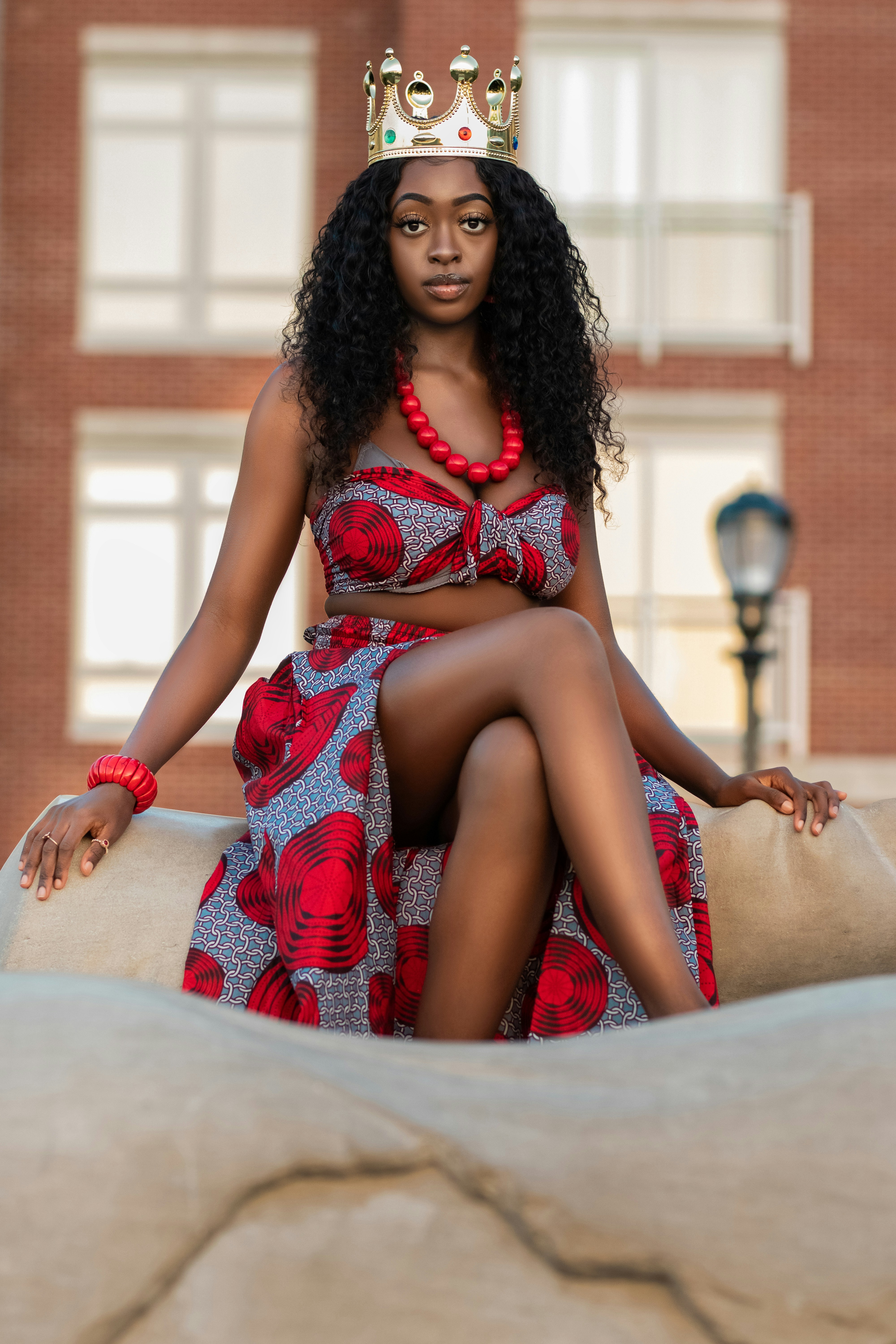 Crown and Confidence: Portrait of Regality in Red and Gold