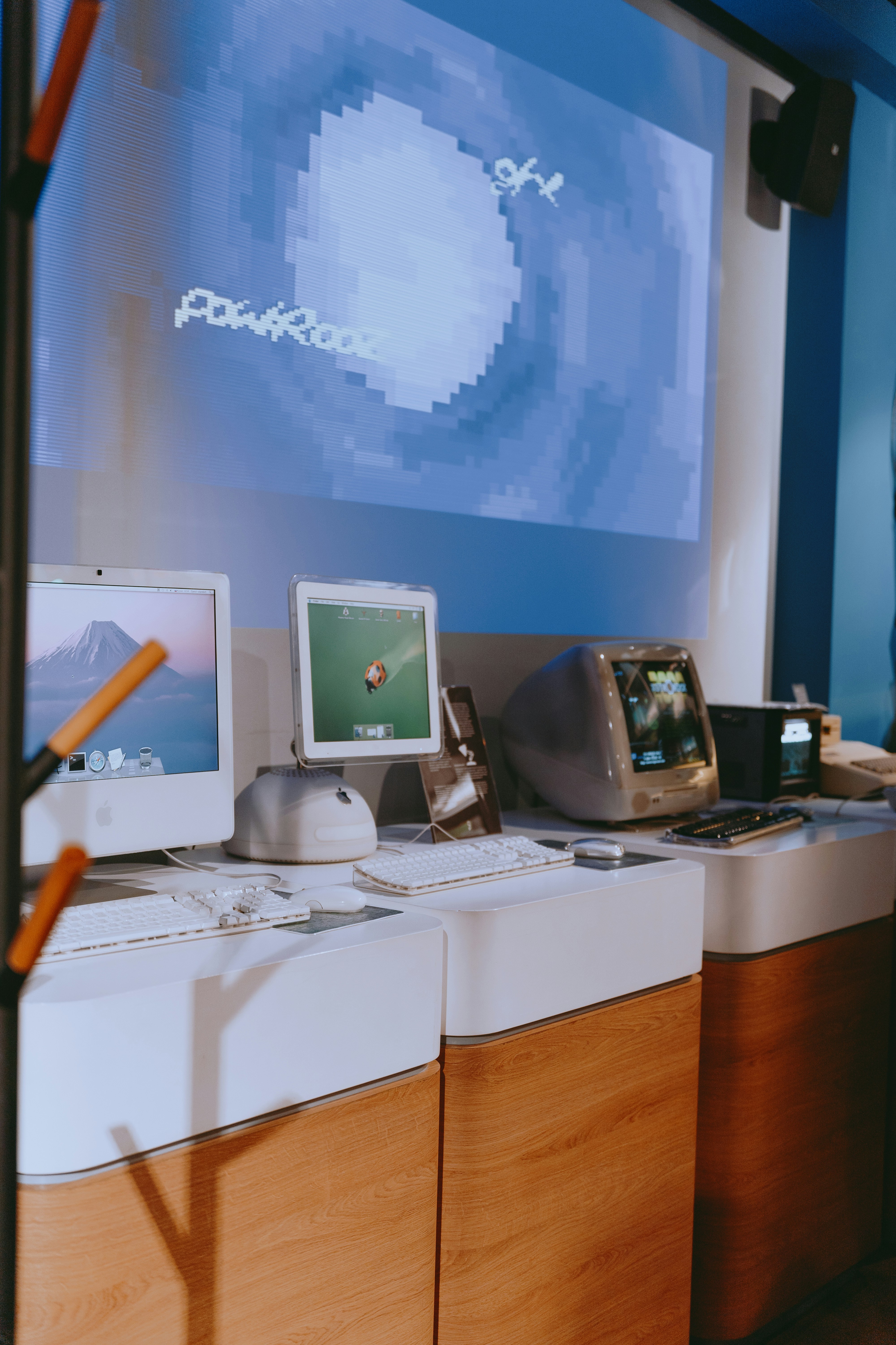 A desk with two computers and a projector screen photo – Free Saint ...