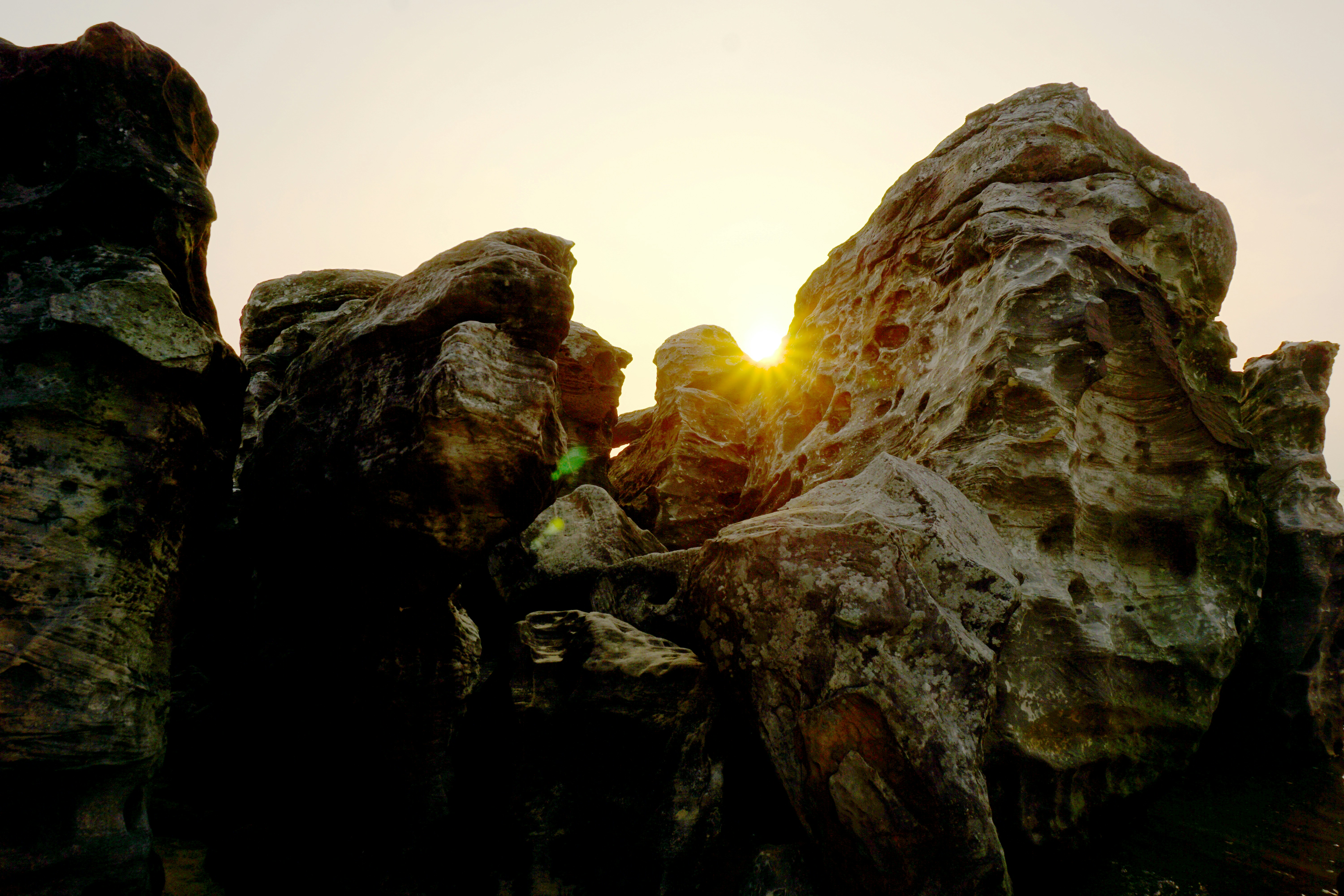 Sunlight in a Narrow Gap Between Jagged Coastal Rocks