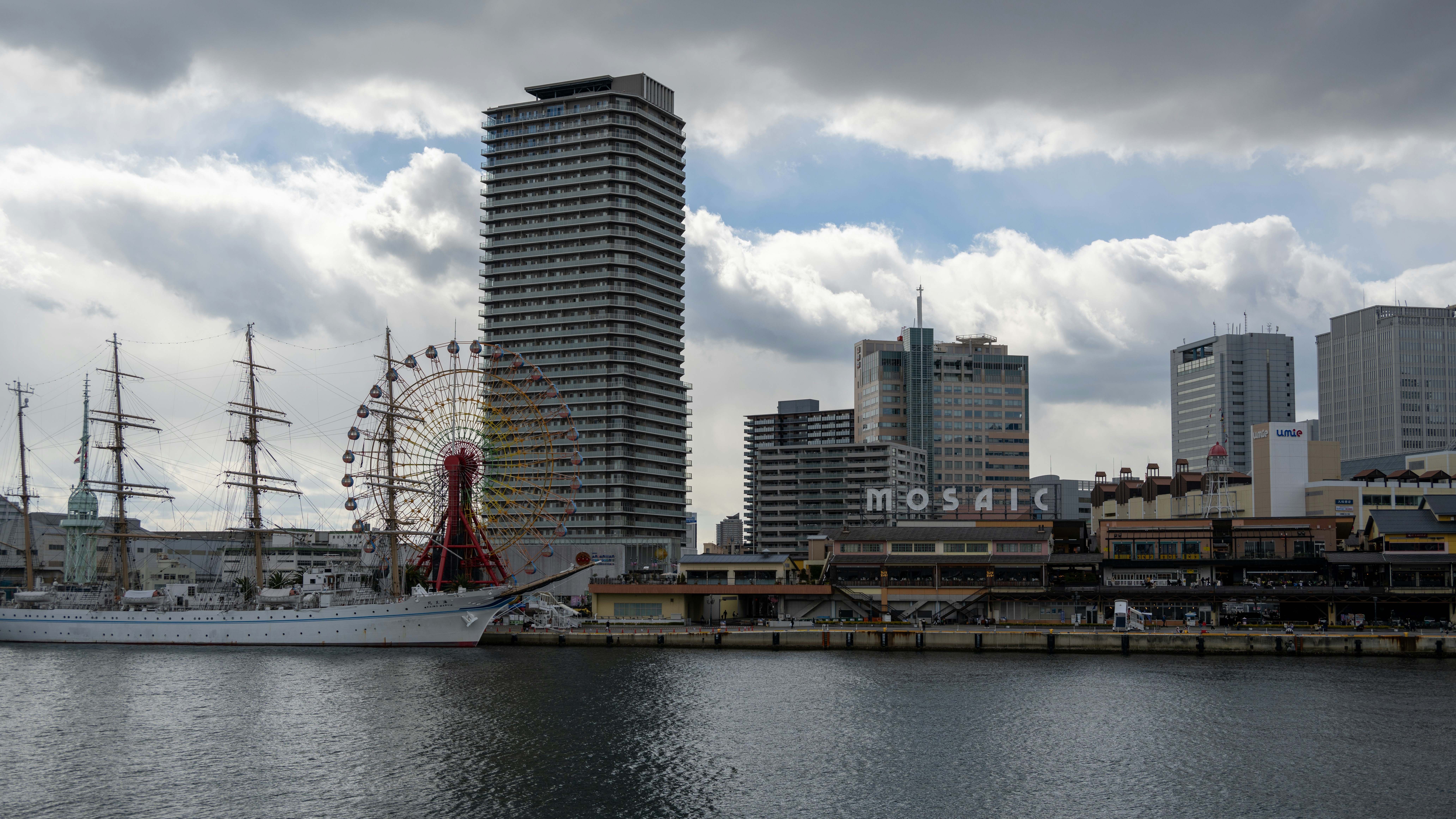 Sailing Echoes by Mosaic: Harbor silhouettes beneath the Ferris wheel and glass towers
