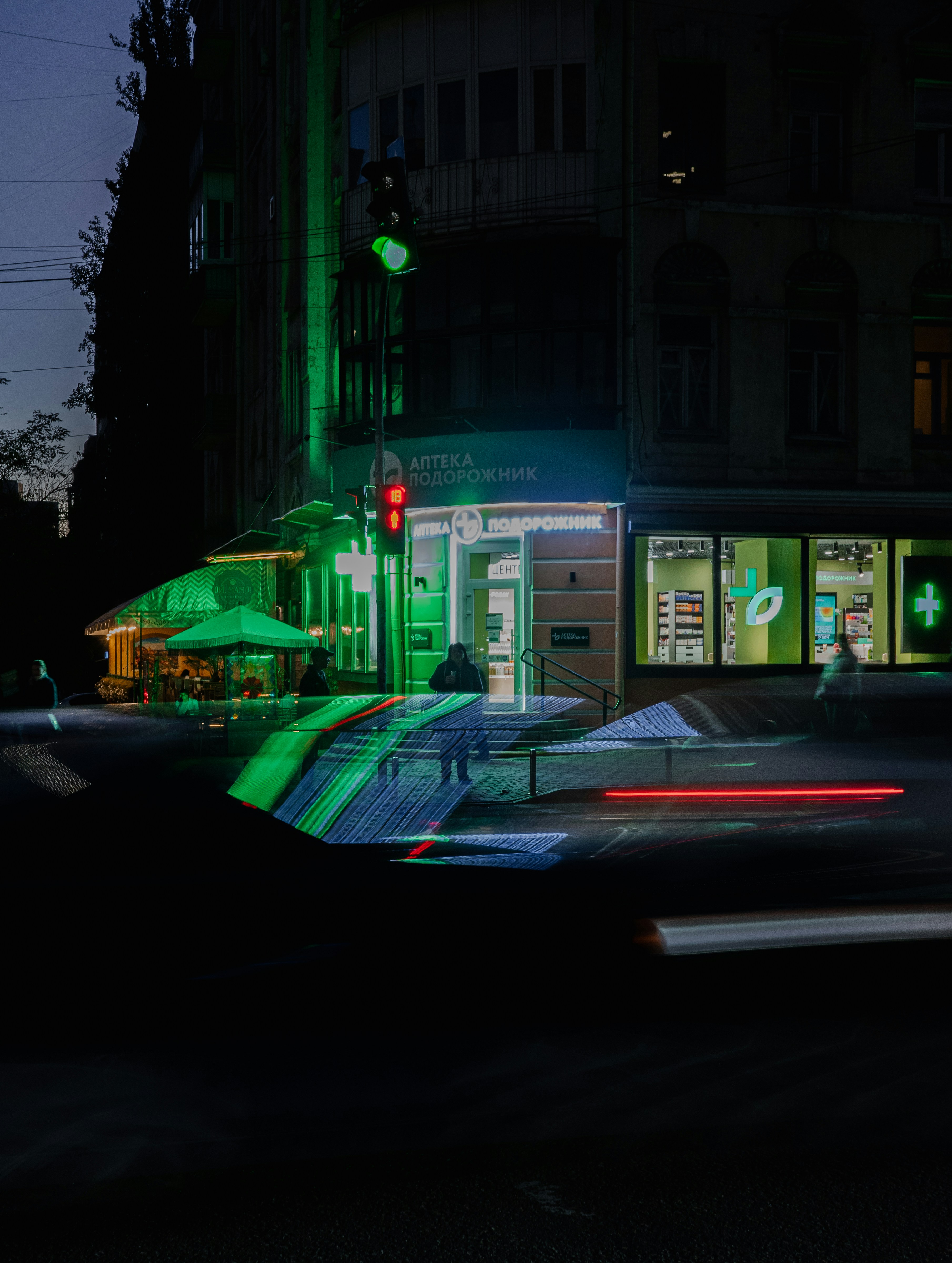 Neon Green Currents: Night Street with Green Signage and Light Trails